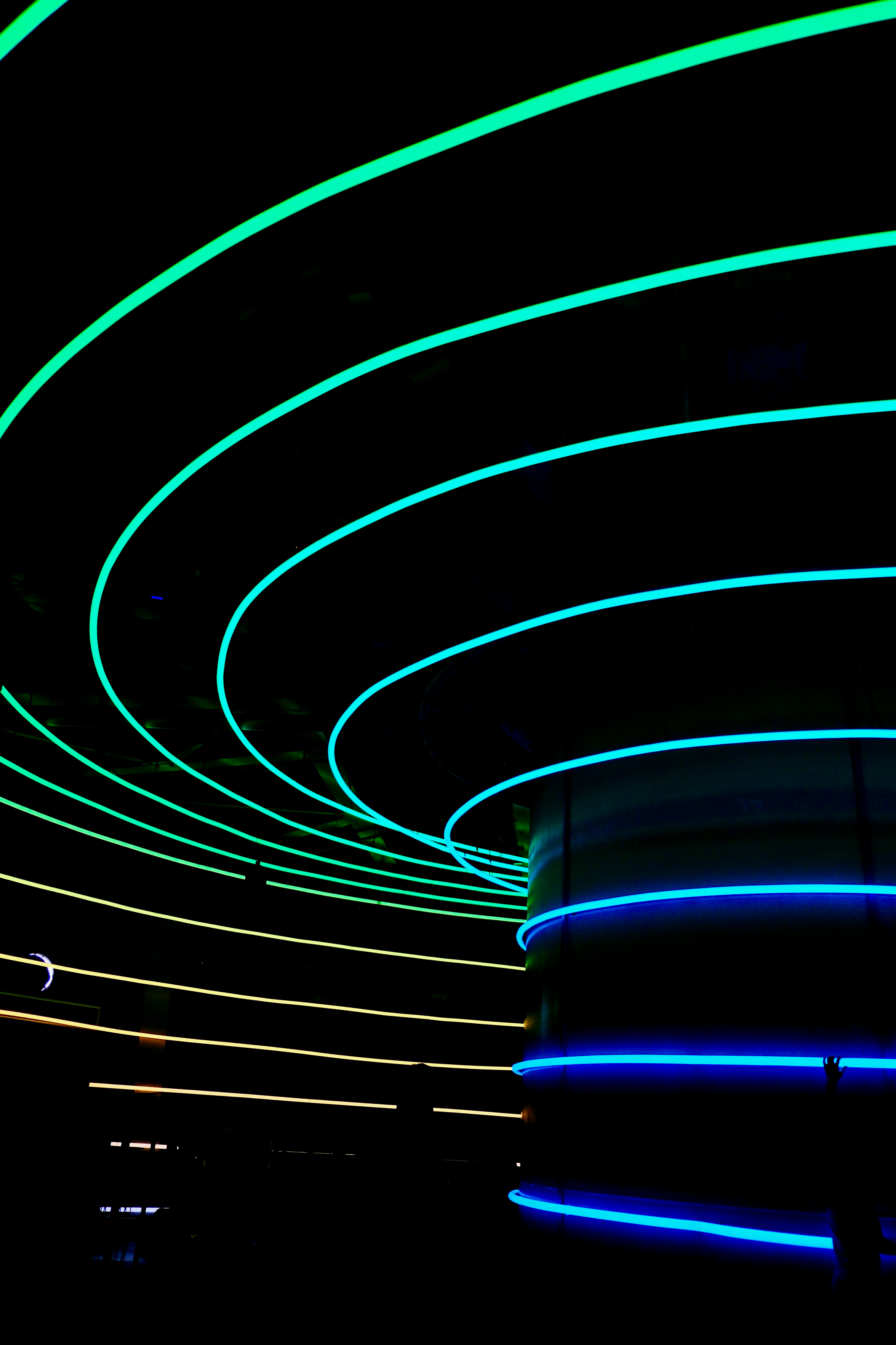 Neon Spirals: Circular Light Rings Wrap a Dark Exterior