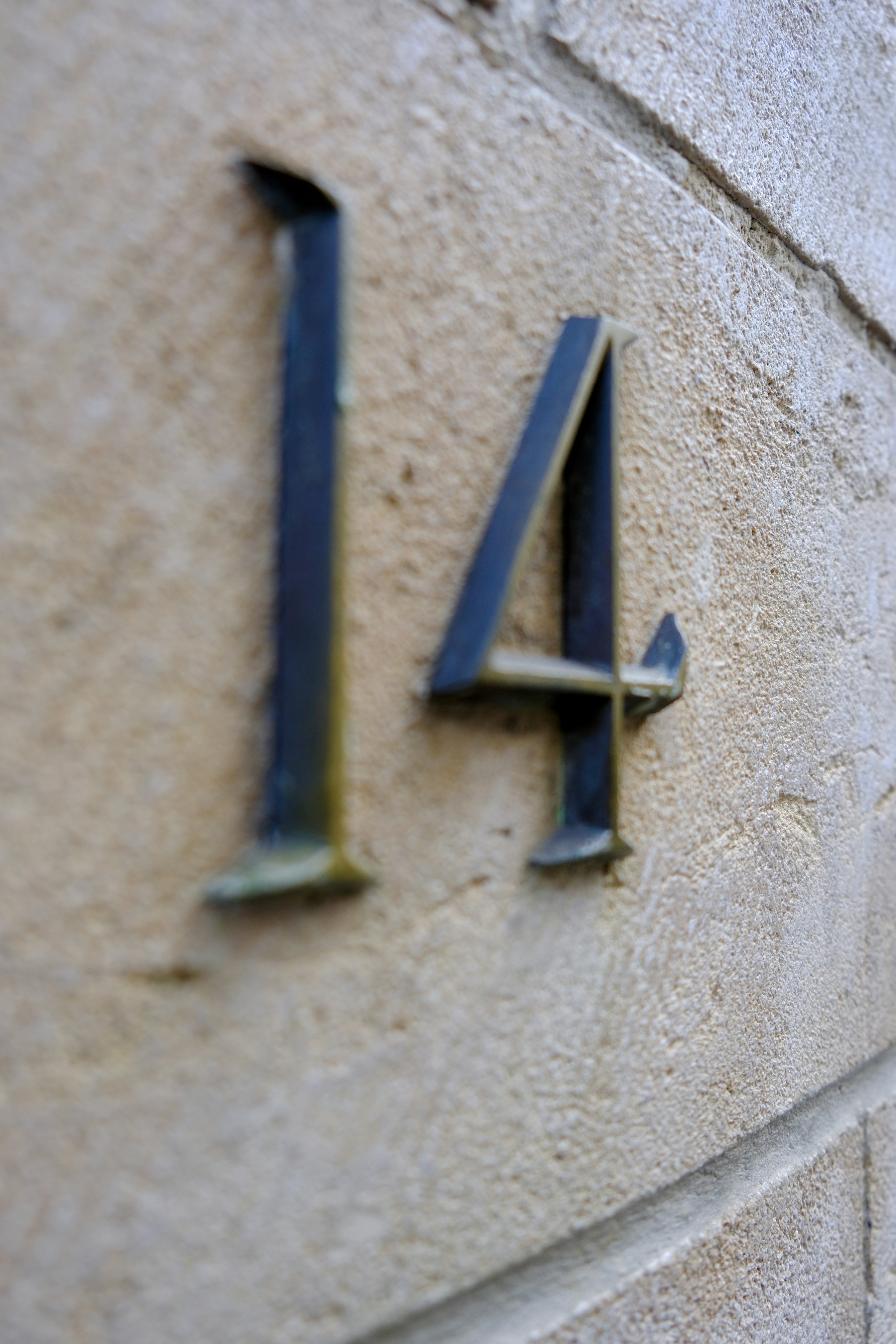 Alphanumeric Doorstep: The Number 4 Emerges from Weathered Stone