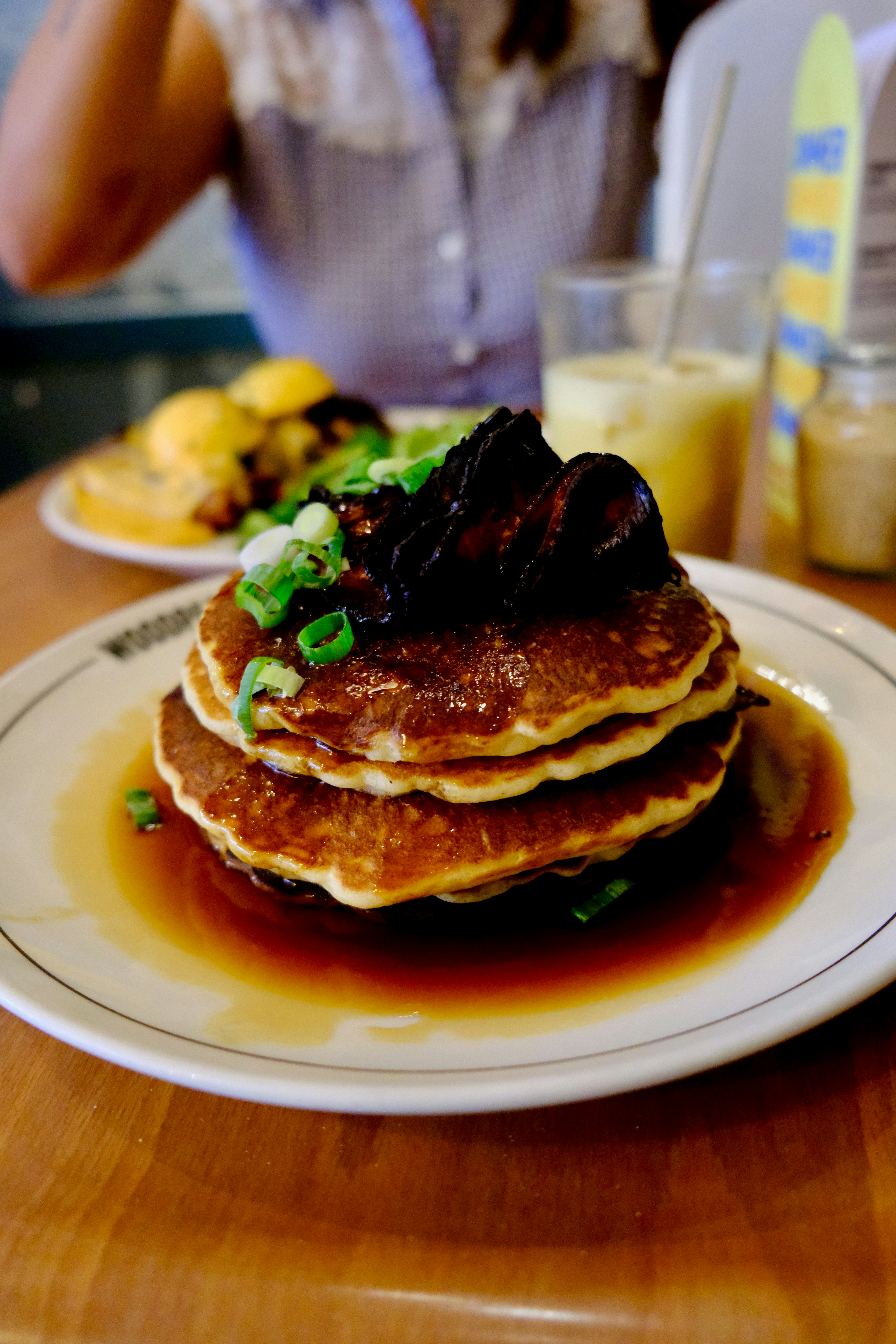 Sticky Sweet Stacks: Glazed Pancakes with Balsamic Glaze Under Warm Café Light