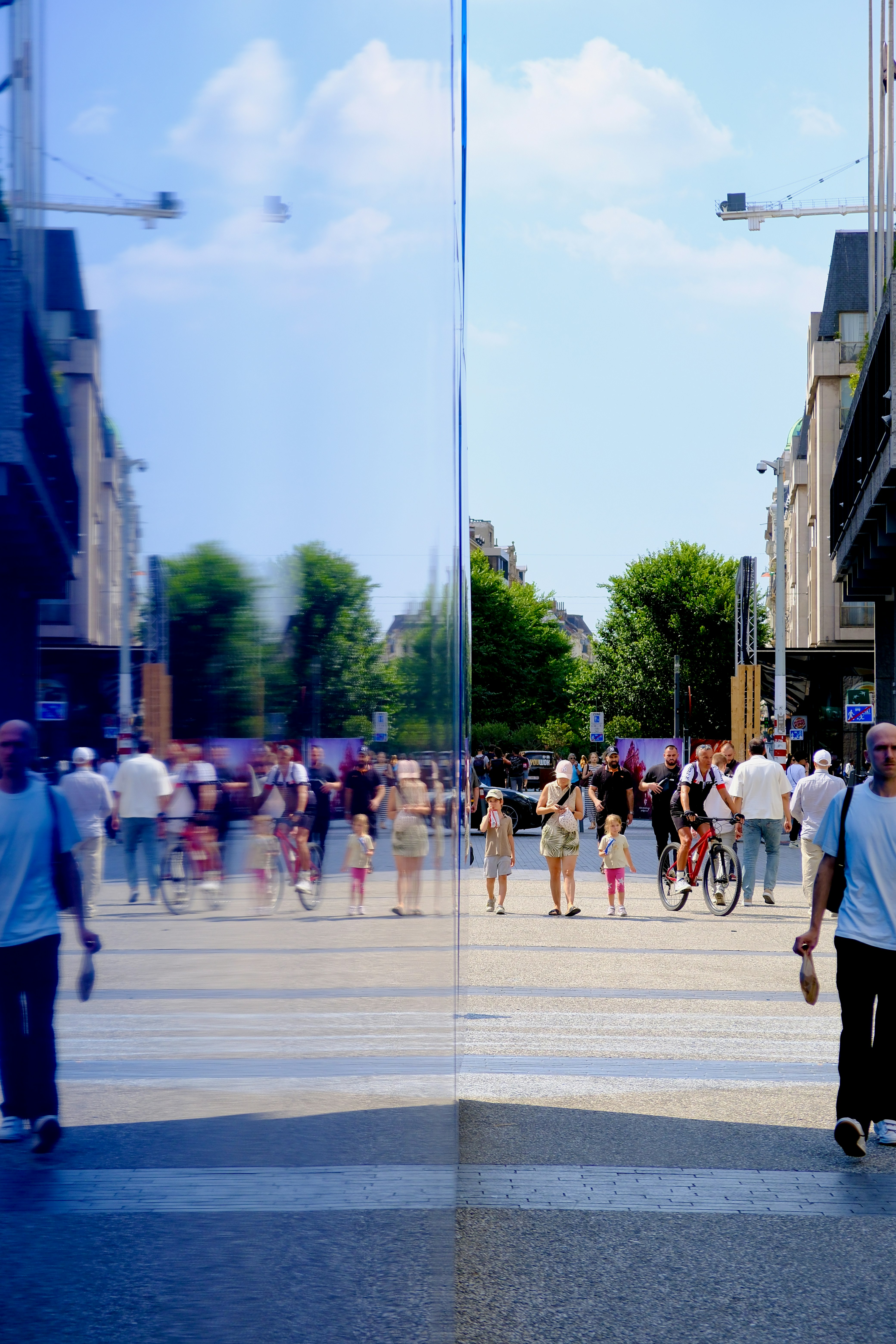 Reflections and Pedestrian Pathway: A City Crossing Split by Glass