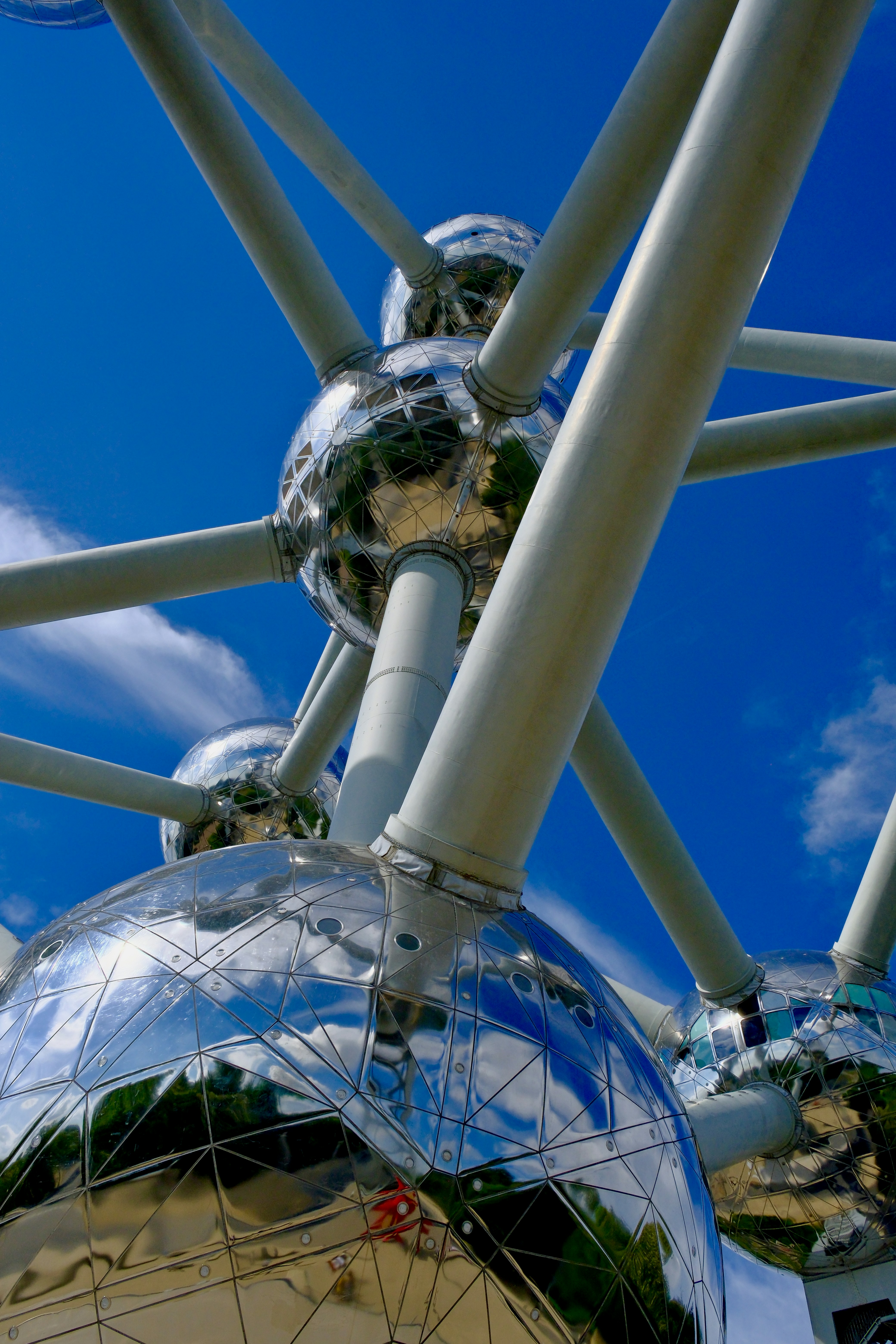Chromed Lattice: A Glinting Portrait of Structural Geometry Beneath a Blue Sky