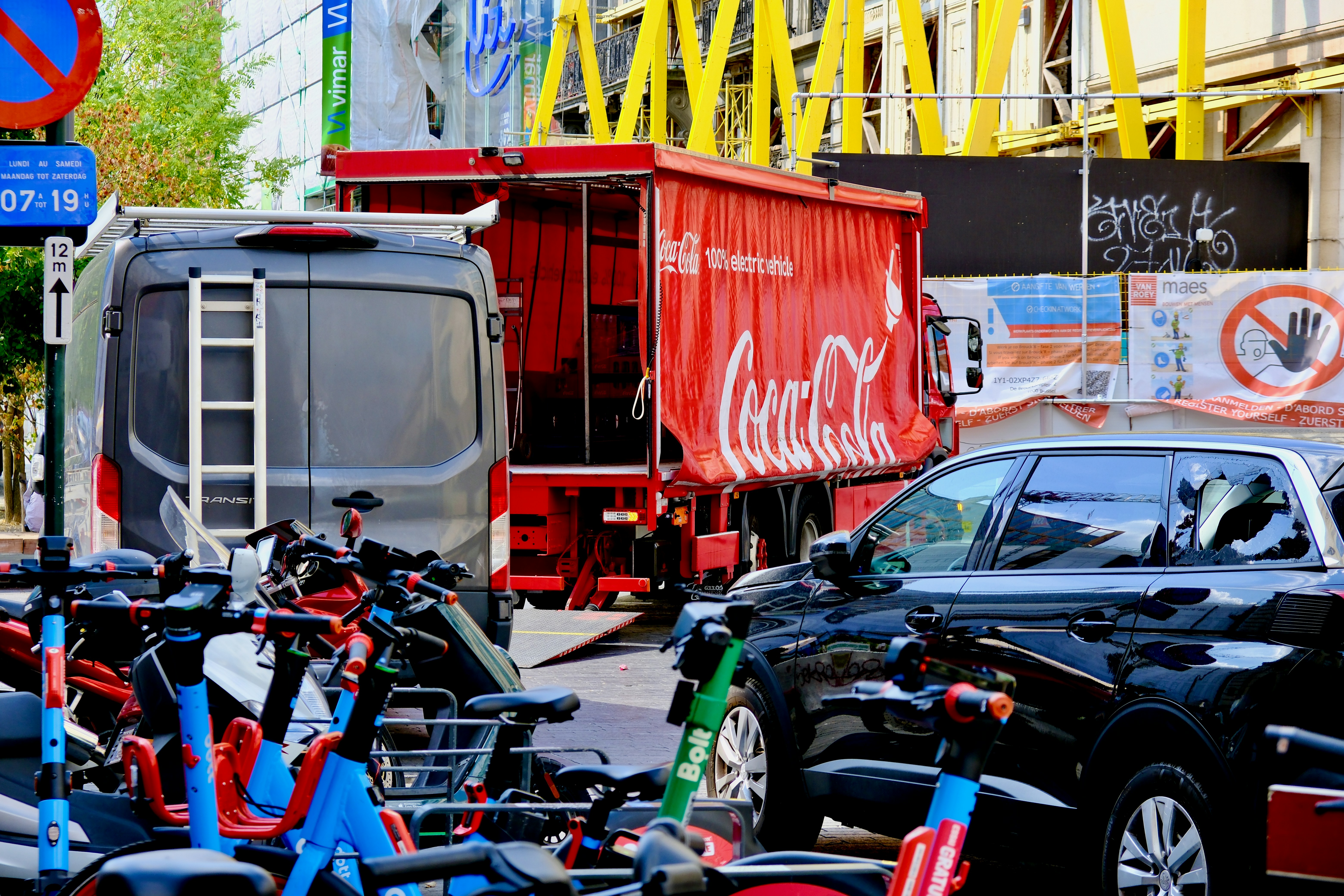 Urban Transit Collision: Coca-Cola Red Truck Among Bicycles and Cars