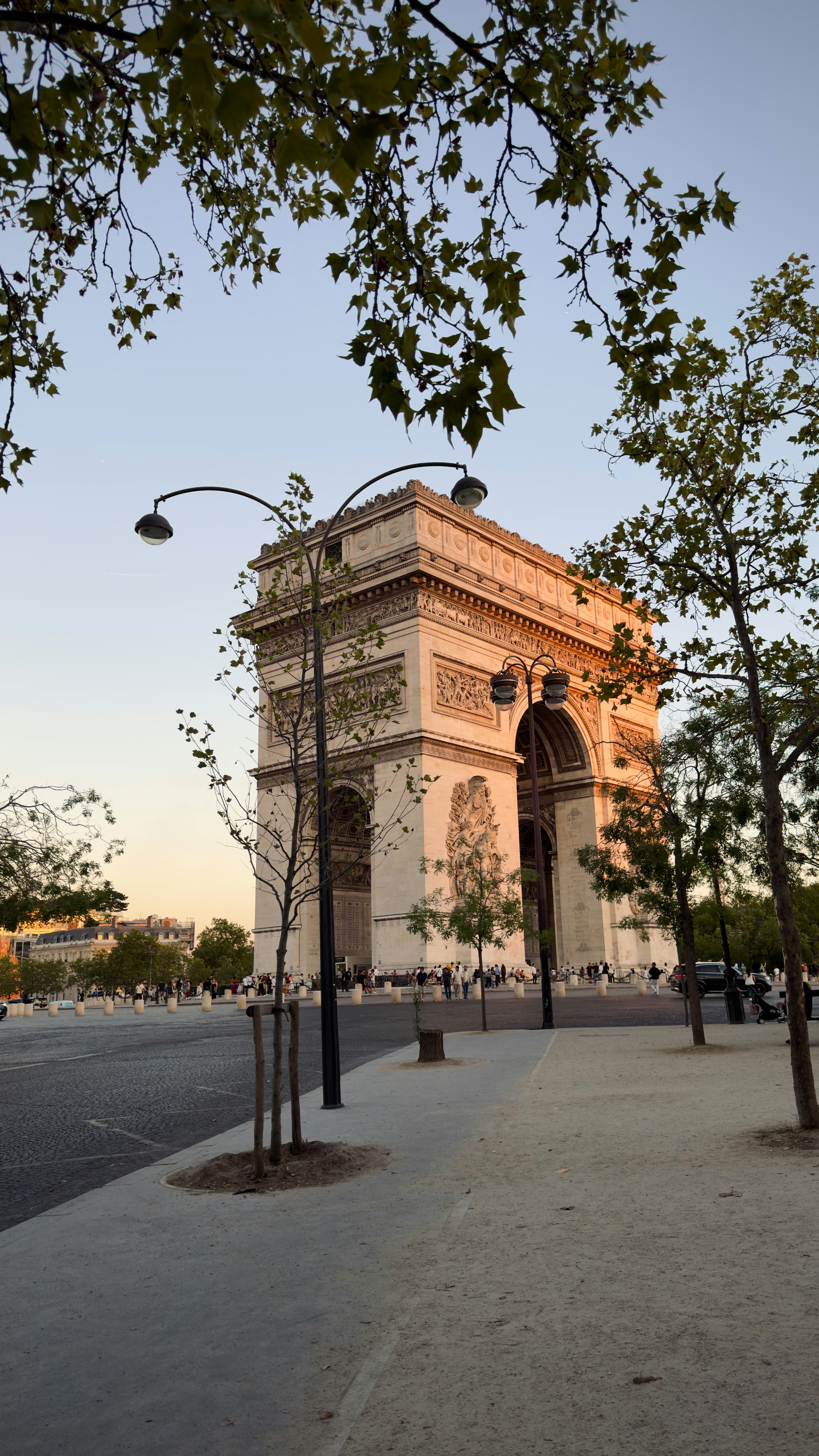 Arc of Light: A Monument framed by Evening Trees
