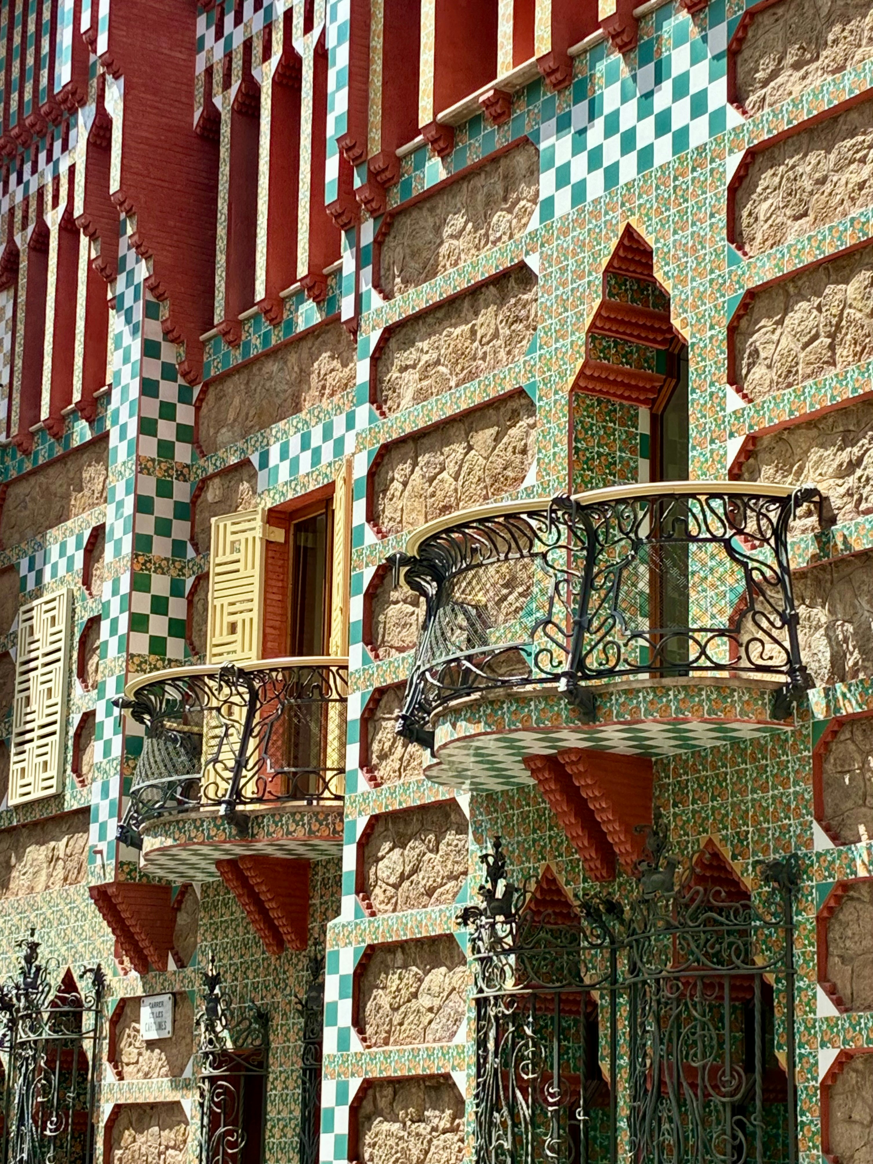 Ornate Tiles and Wrought-iron Balconies on a Colorful Facade