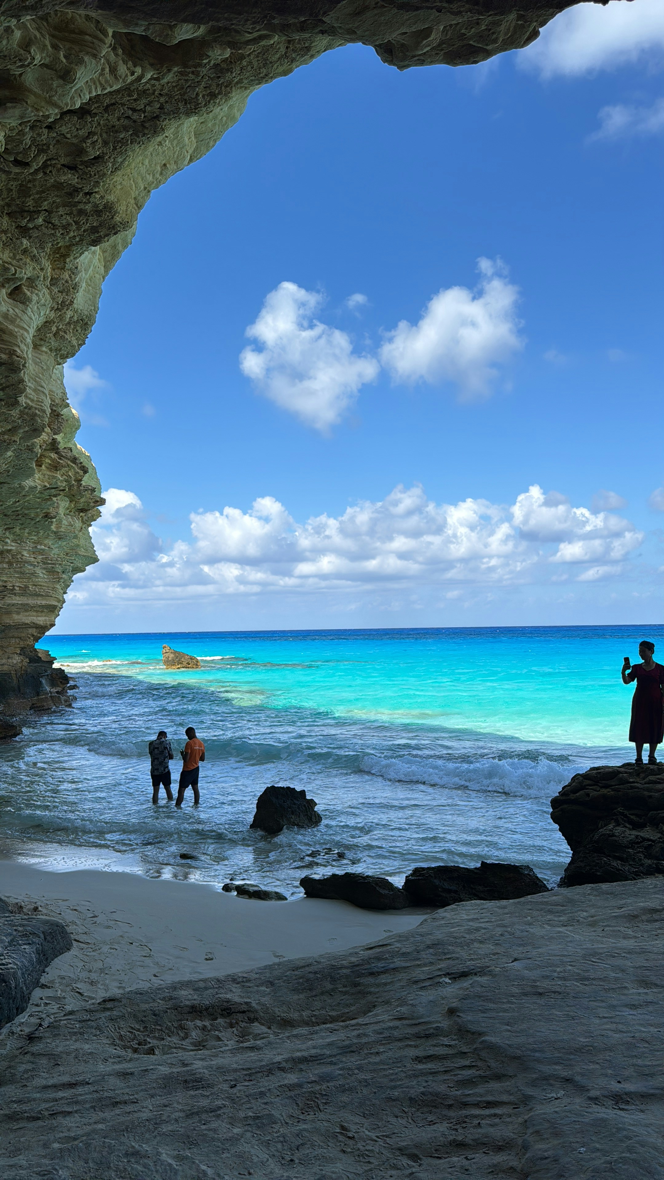 Sea Cave Vista: Cropped Horizon and People by the Tide