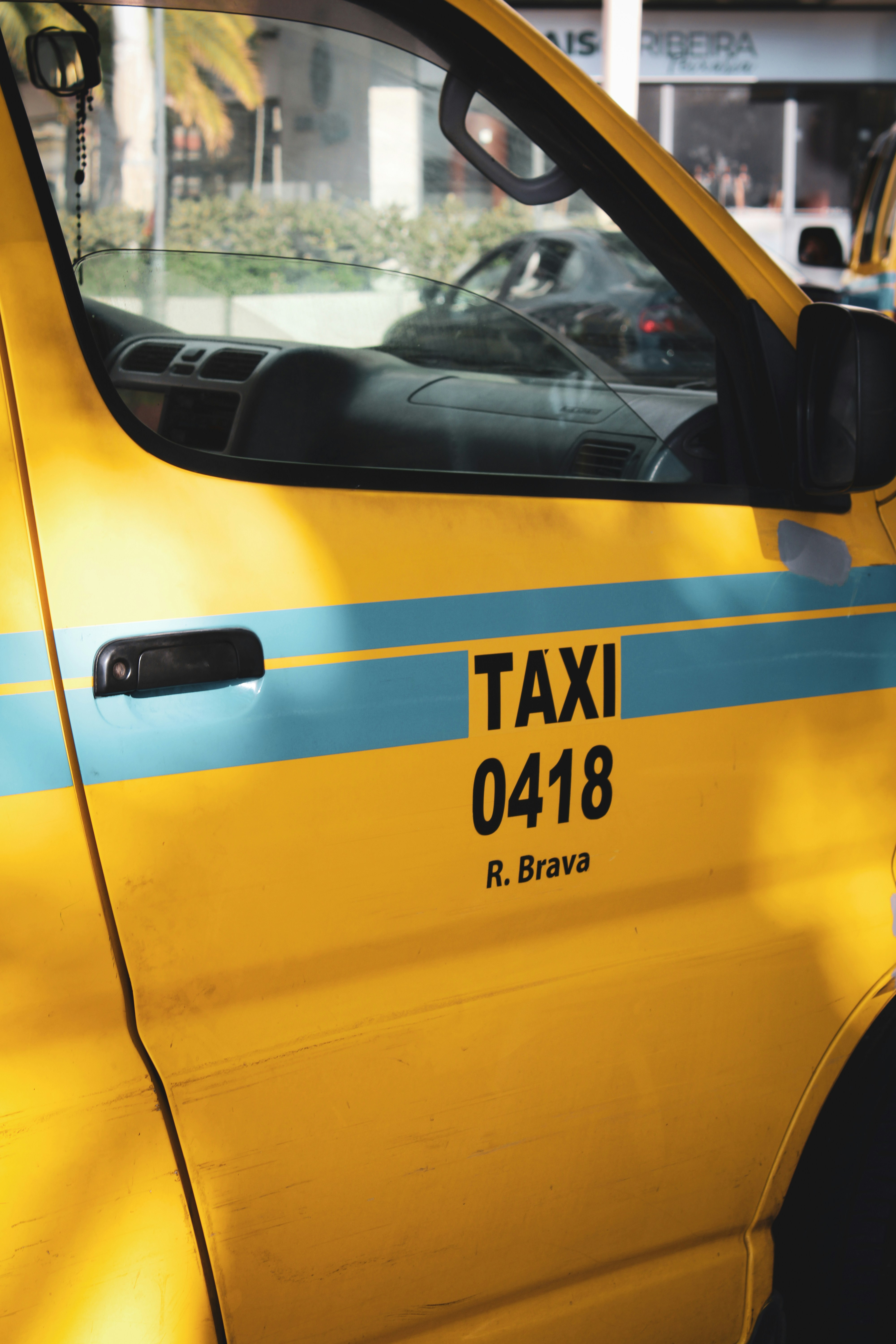 Yellow Taxi Door: Bold Branding and Window View