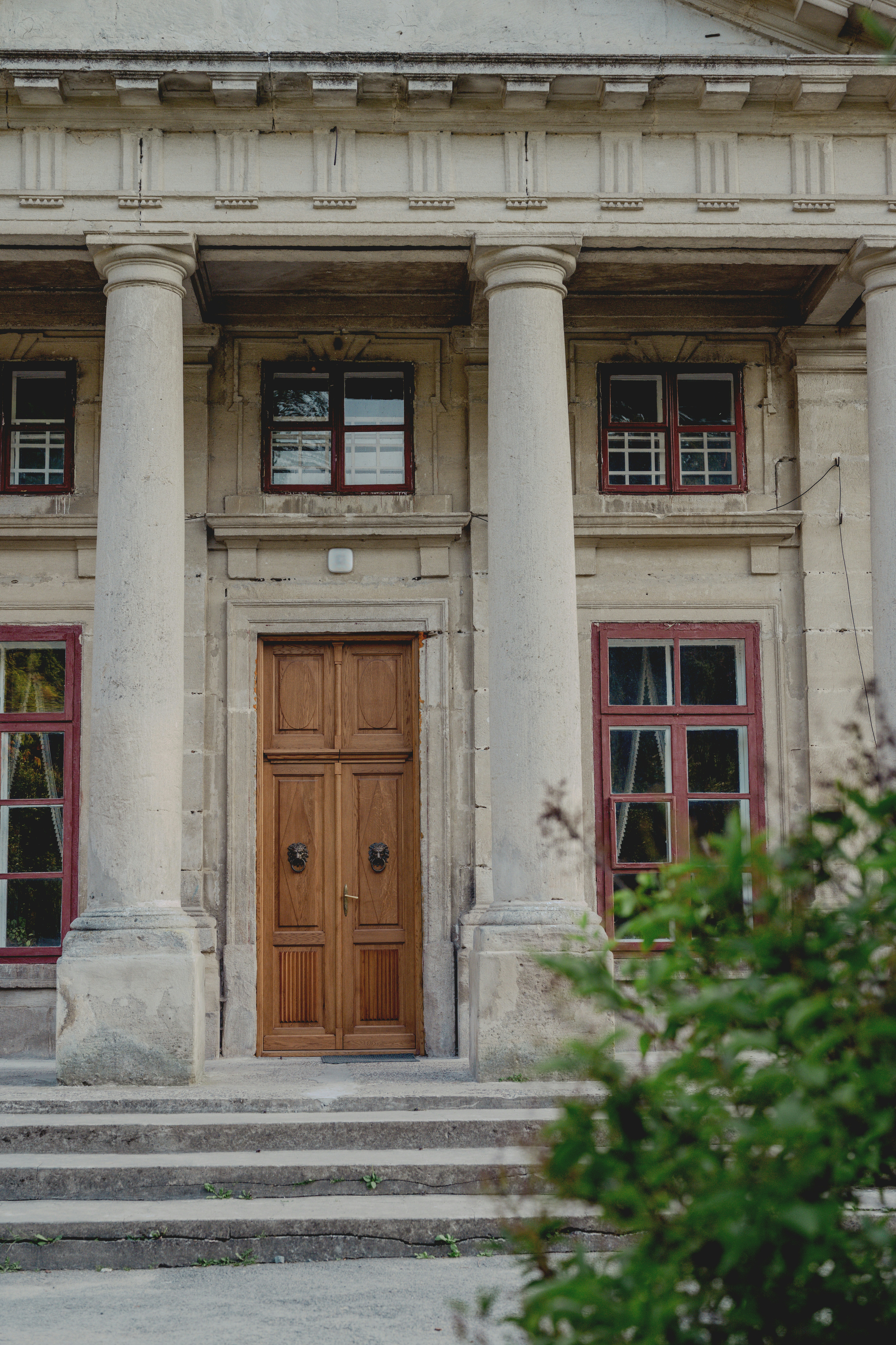 Stone Columns and Wooden Door: An Old Estate Facade