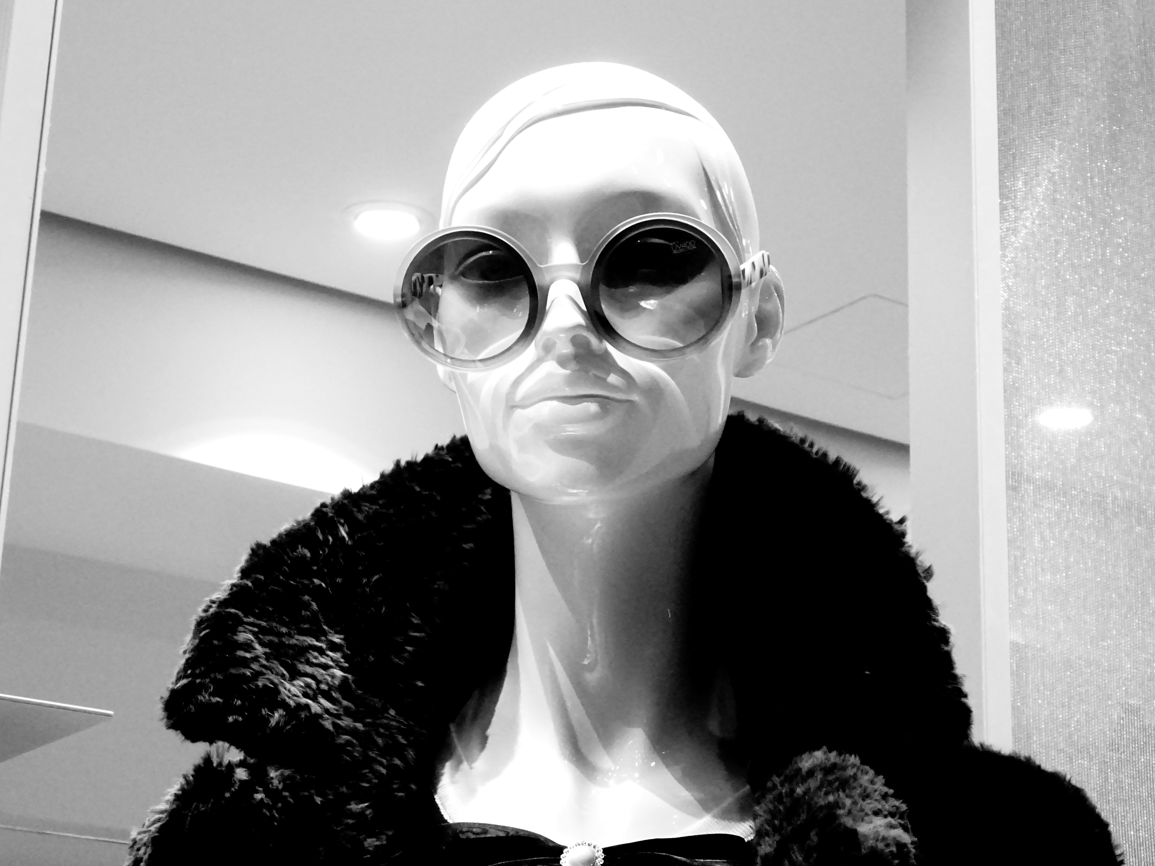 Chic in Mono: Portrait of a Bold Silhouette in Round Glasses