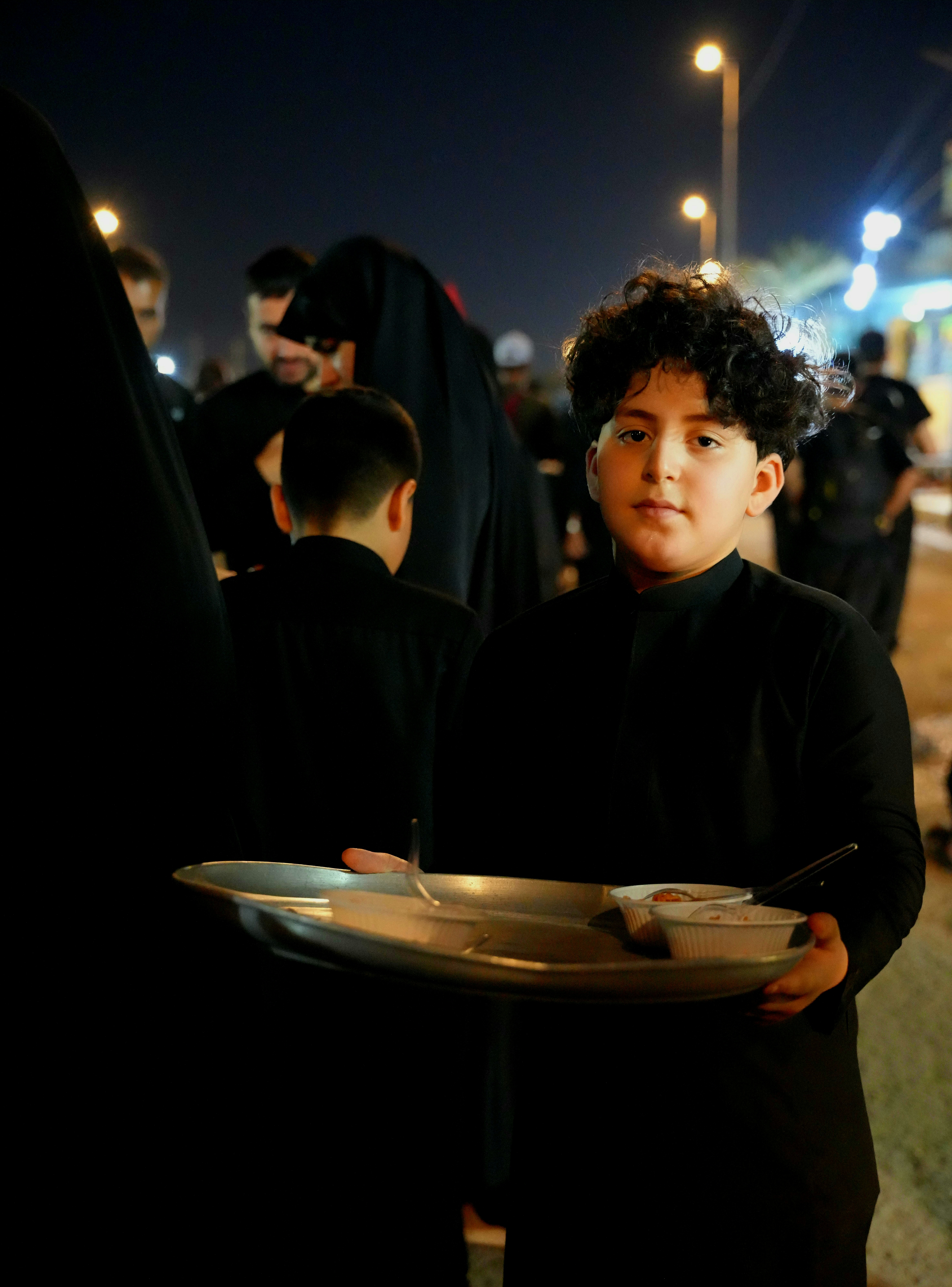 Midnight Grace: A Quiet Portrait of a Child in Night Market Lights