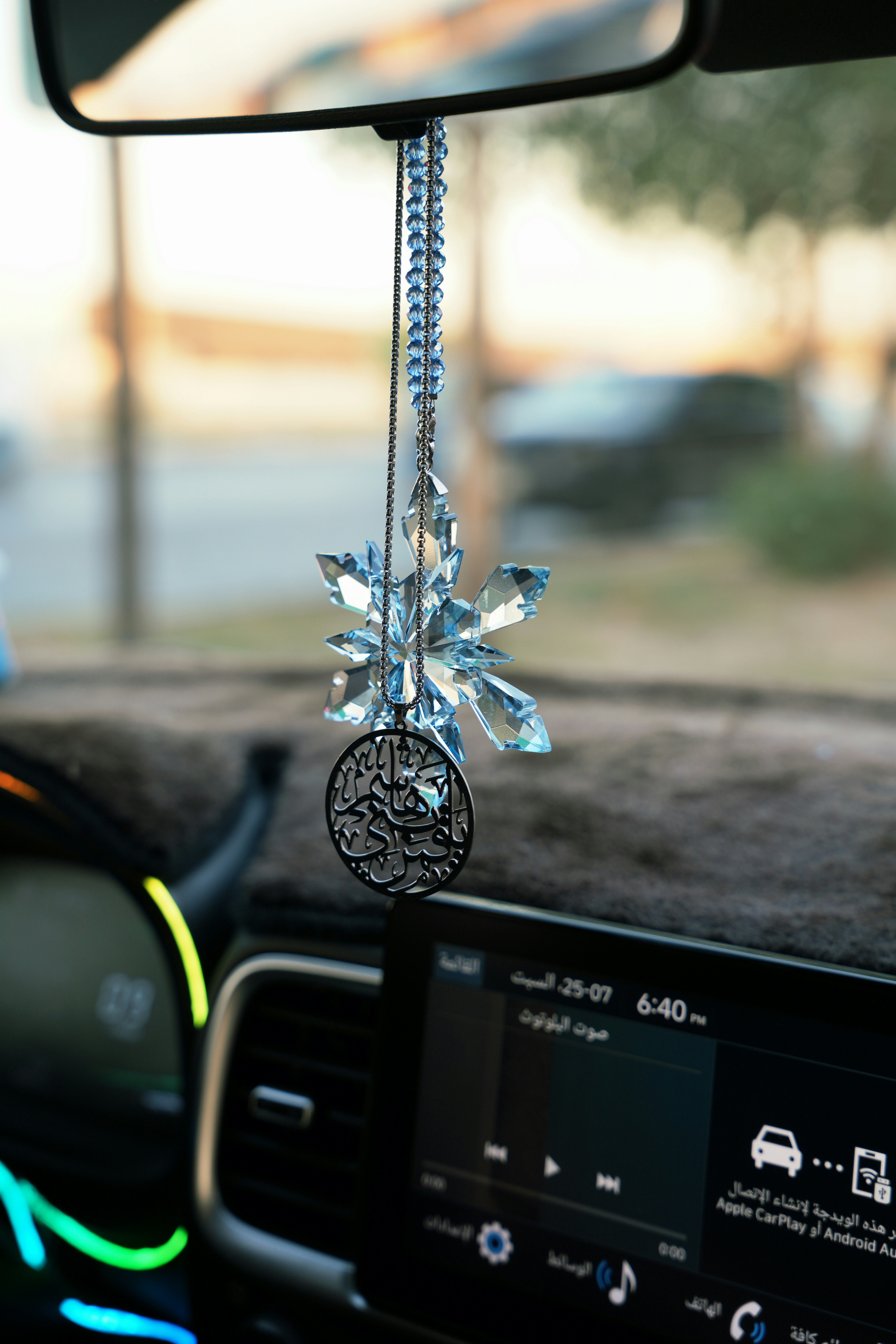 Hanging Ornament in a Car, Backlit by Sunset