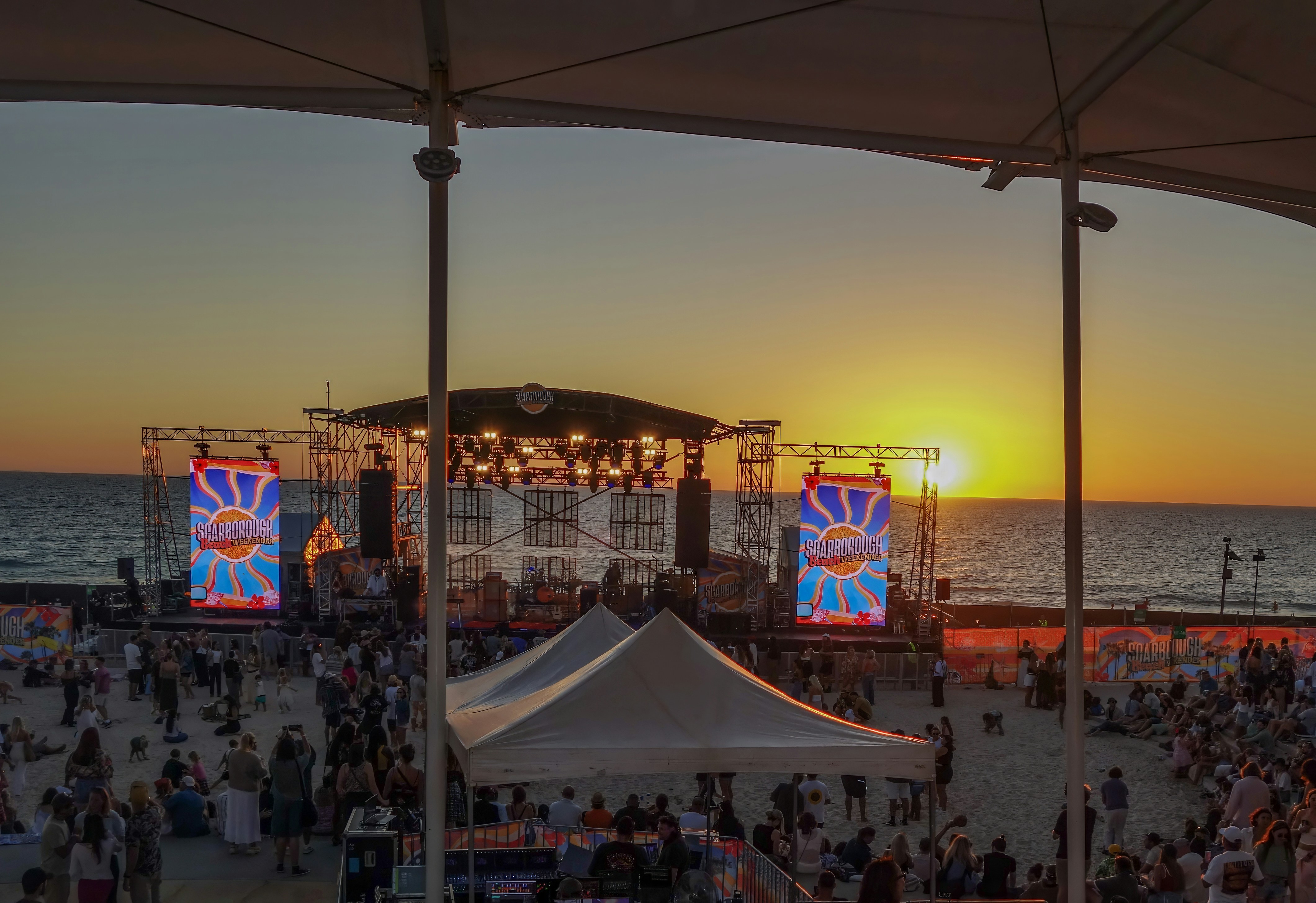 Sunset Stage: A Beach Concert Illuminates the Crowd