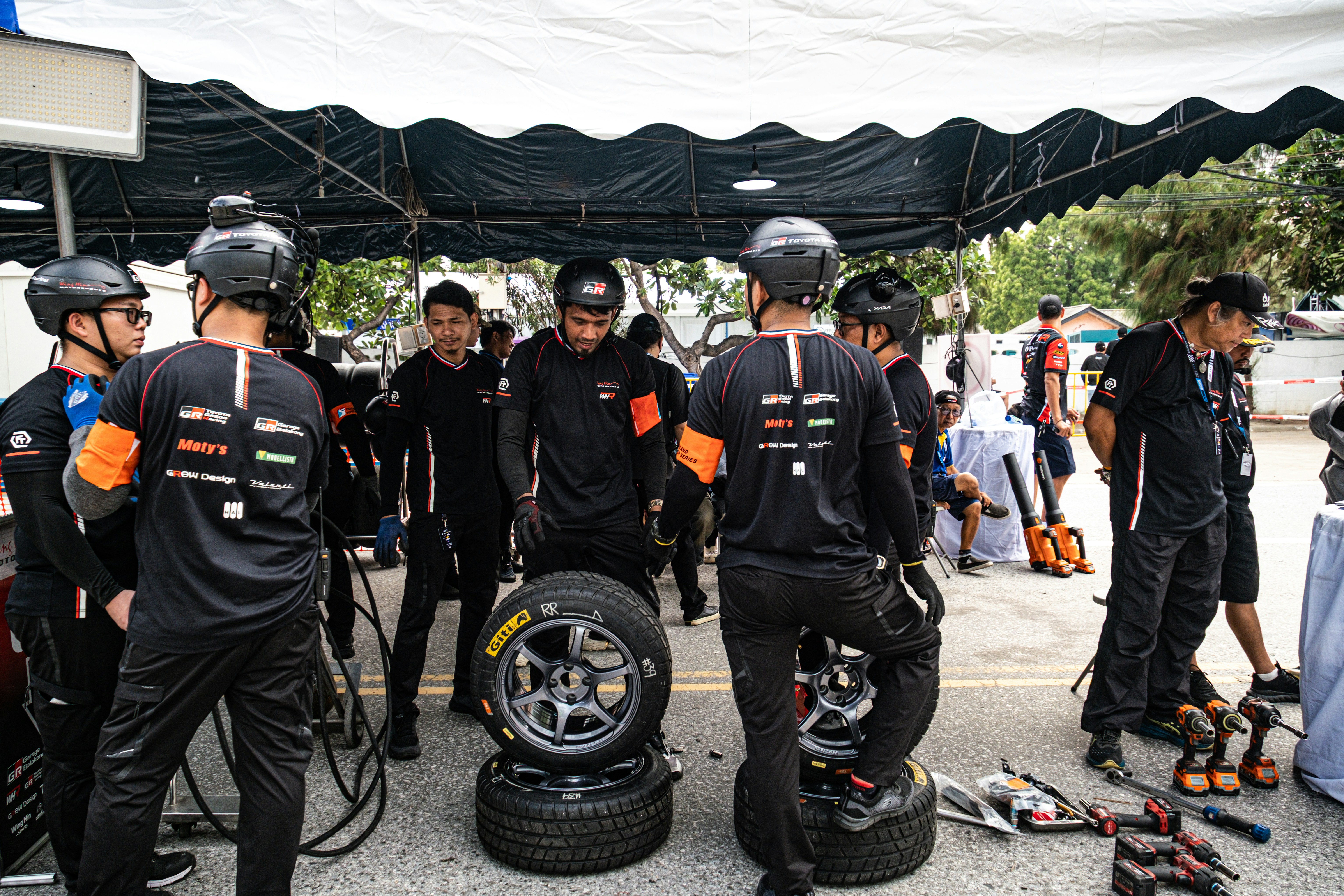 Racing Pit: Mechanics at Work under the Tarp