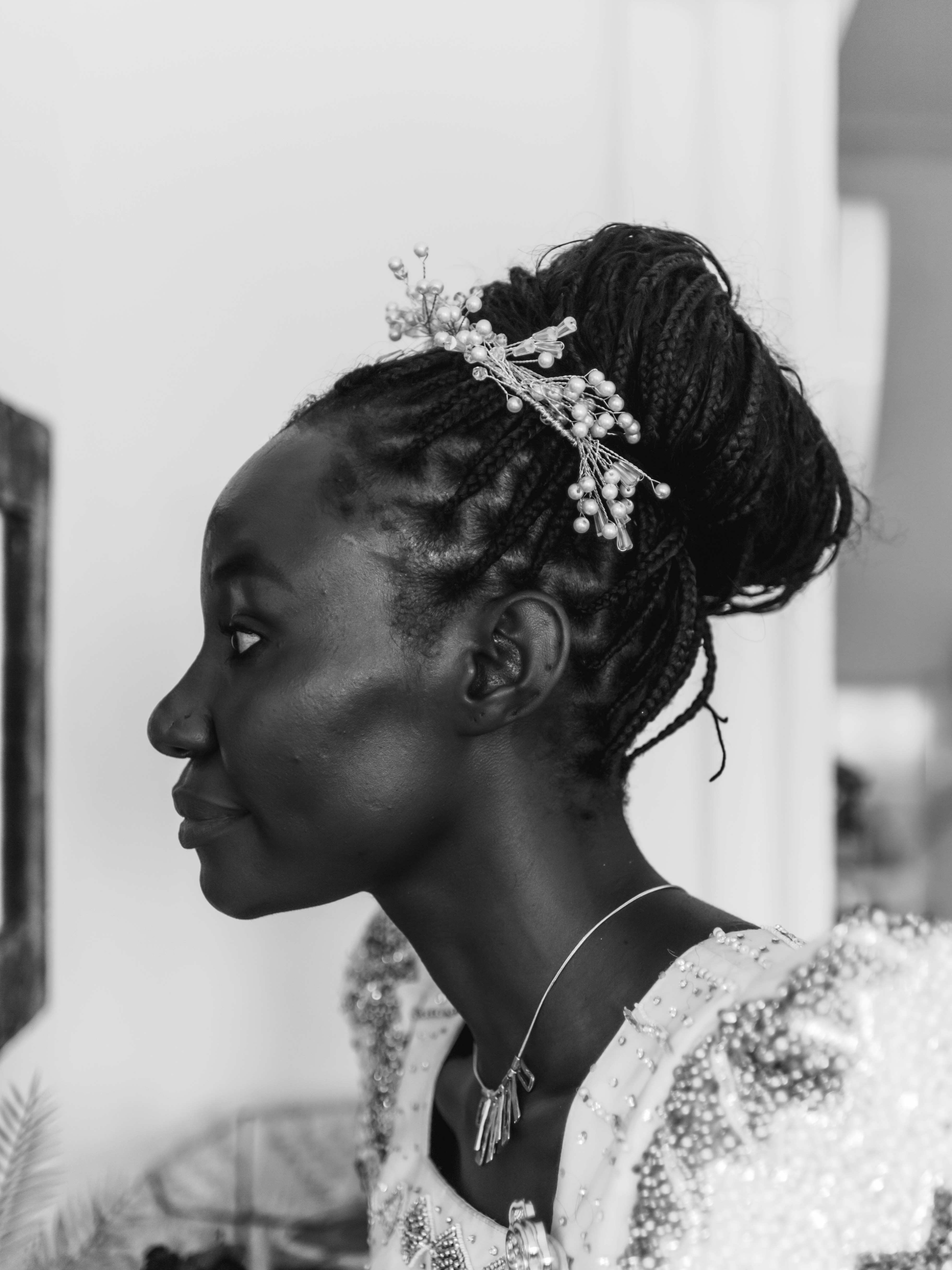 Profile of Grace: A Regal Updo with Pearl Adornments