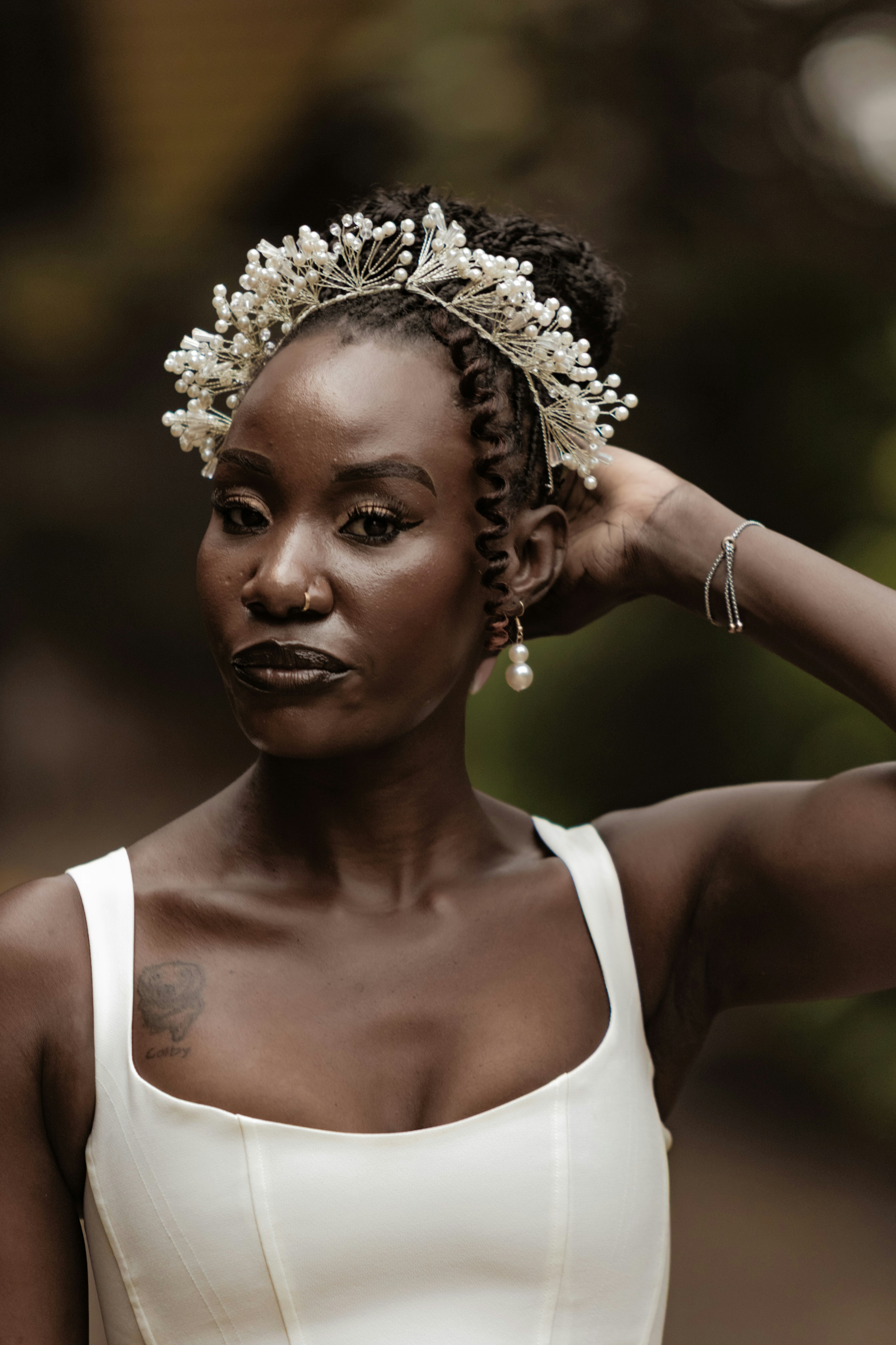 Elegance in Bloom: a poised portrait with pearl crown