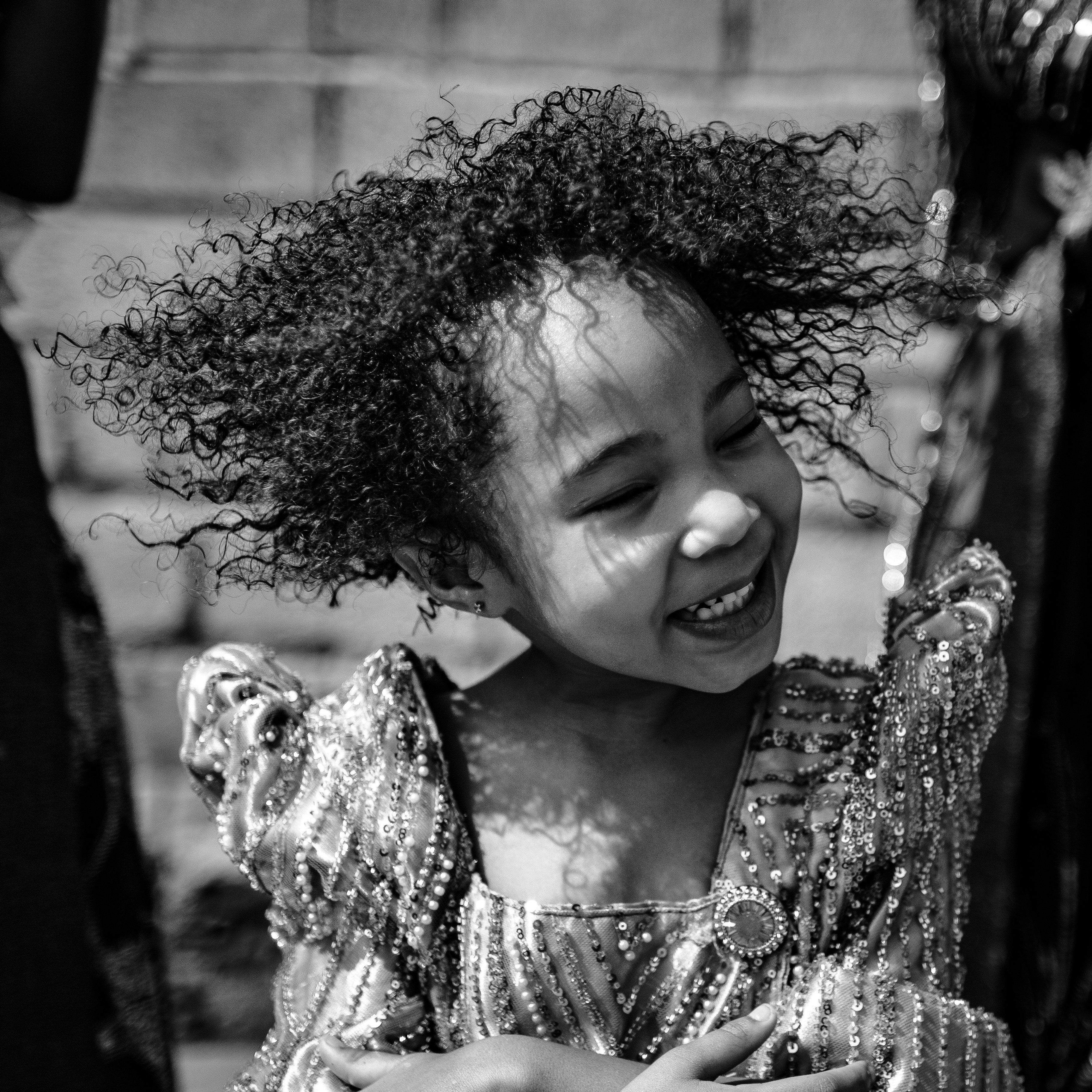 Joy in Beaded Light: A Child’s Delight in Prismatic Glamor