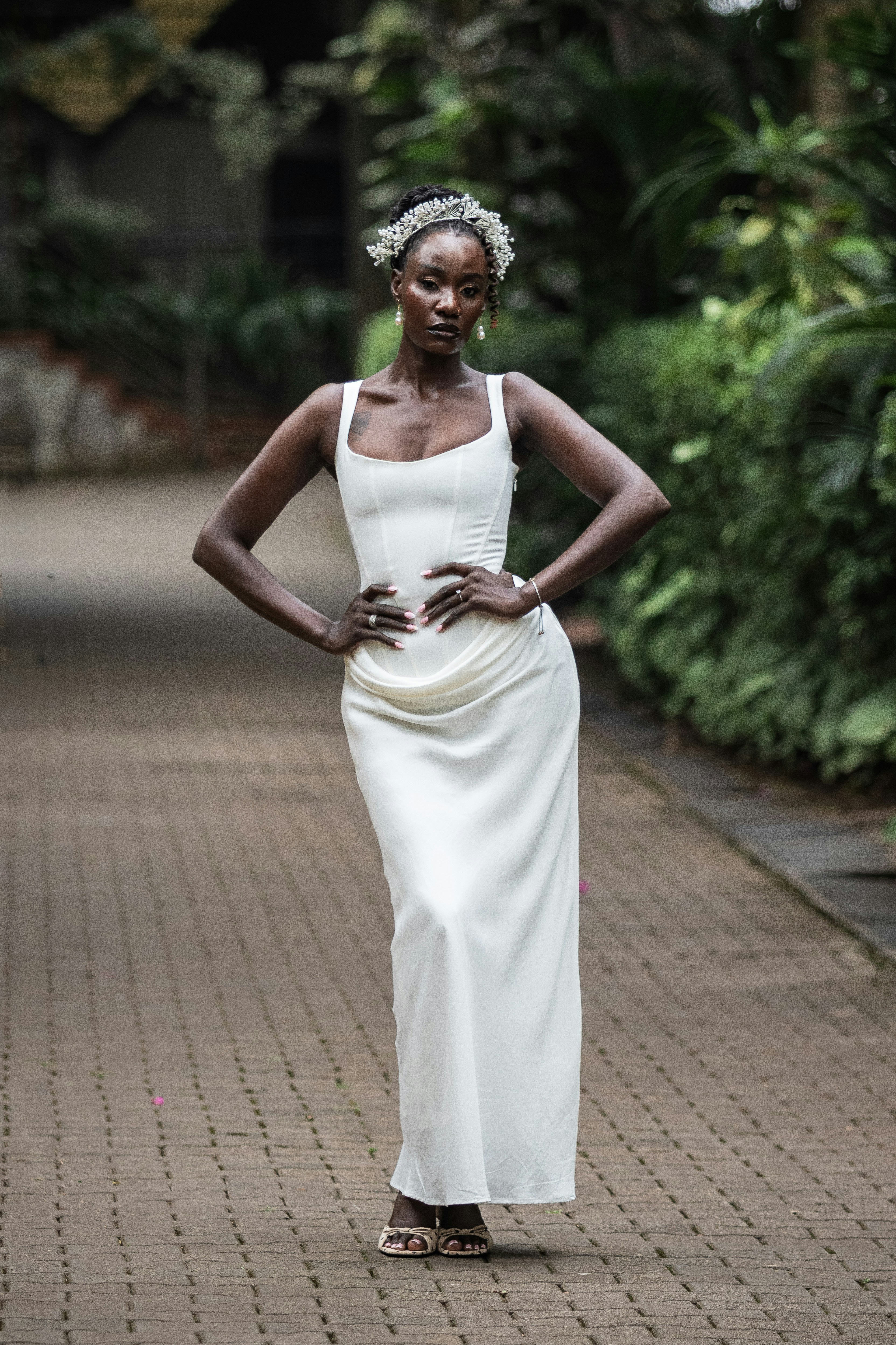 Grace in White: A Portrait of Poise Along the Garden Path