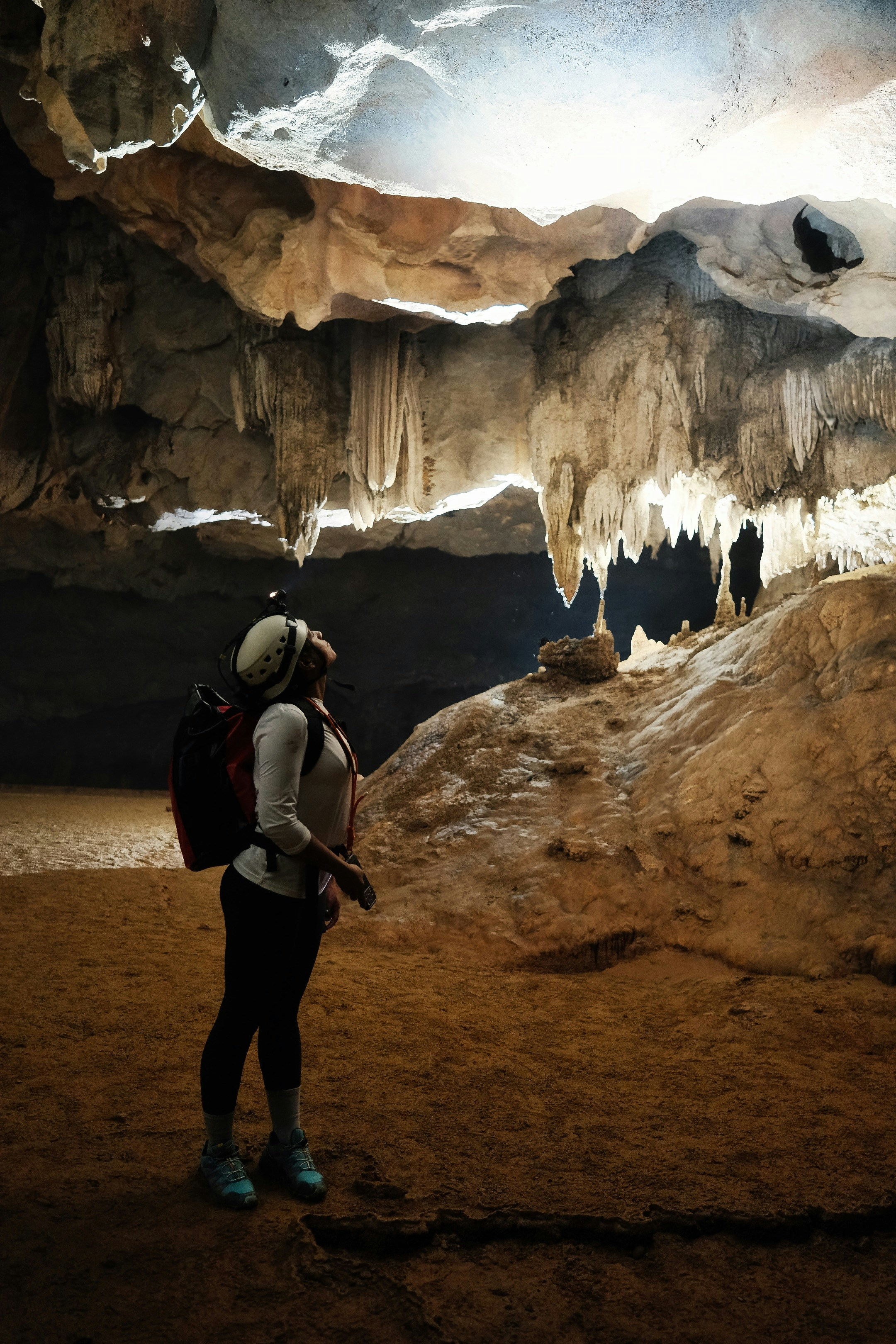 Stalactite Cathedral: A Climber Gazes Up at Nature’s Pillars