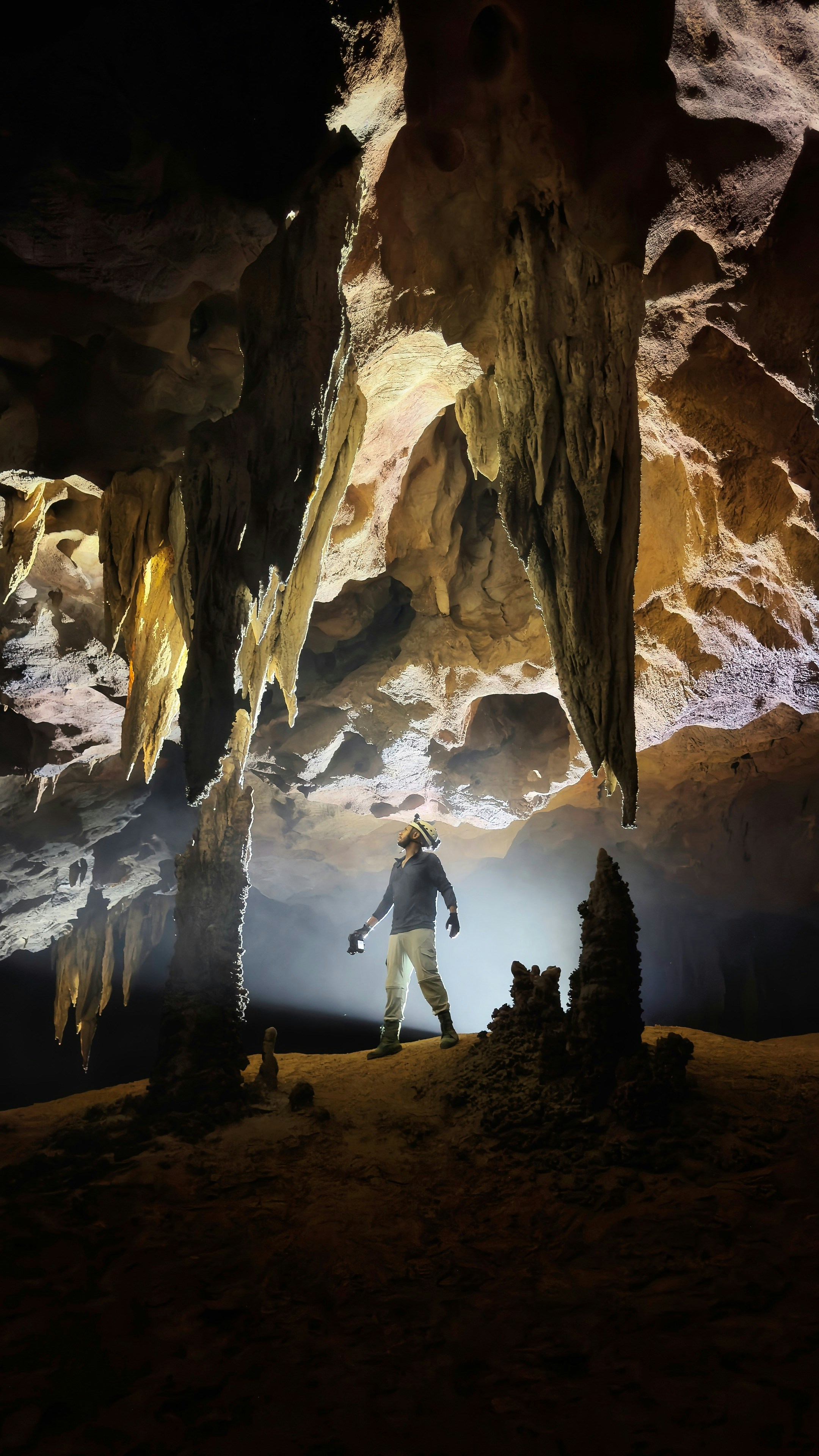 Stalactite Cathedral: A Lone Explorer Beneath Ancient Spears