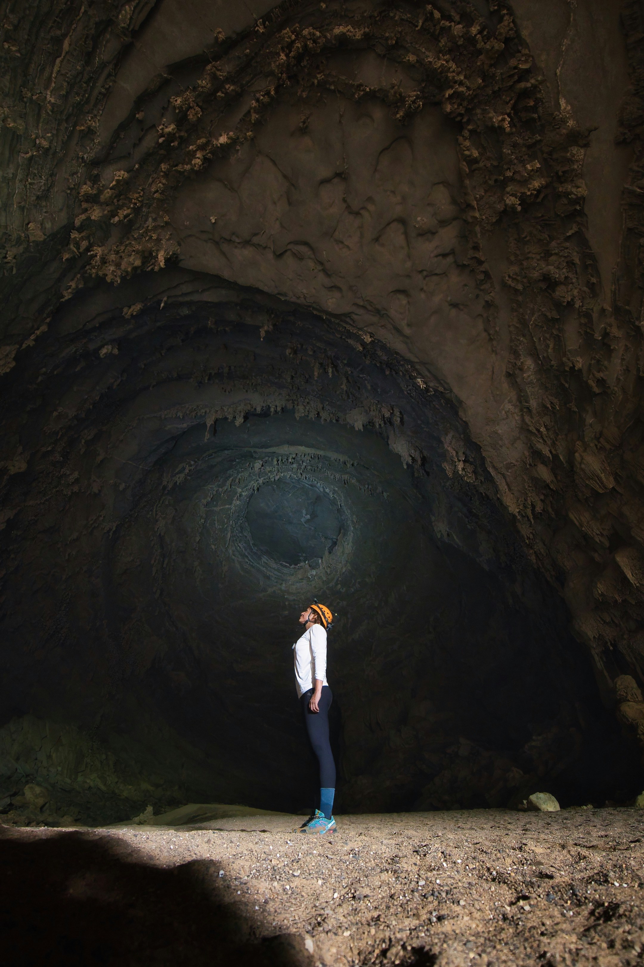 Human outcrop: wanderer in a volcanic tunnel of shadow