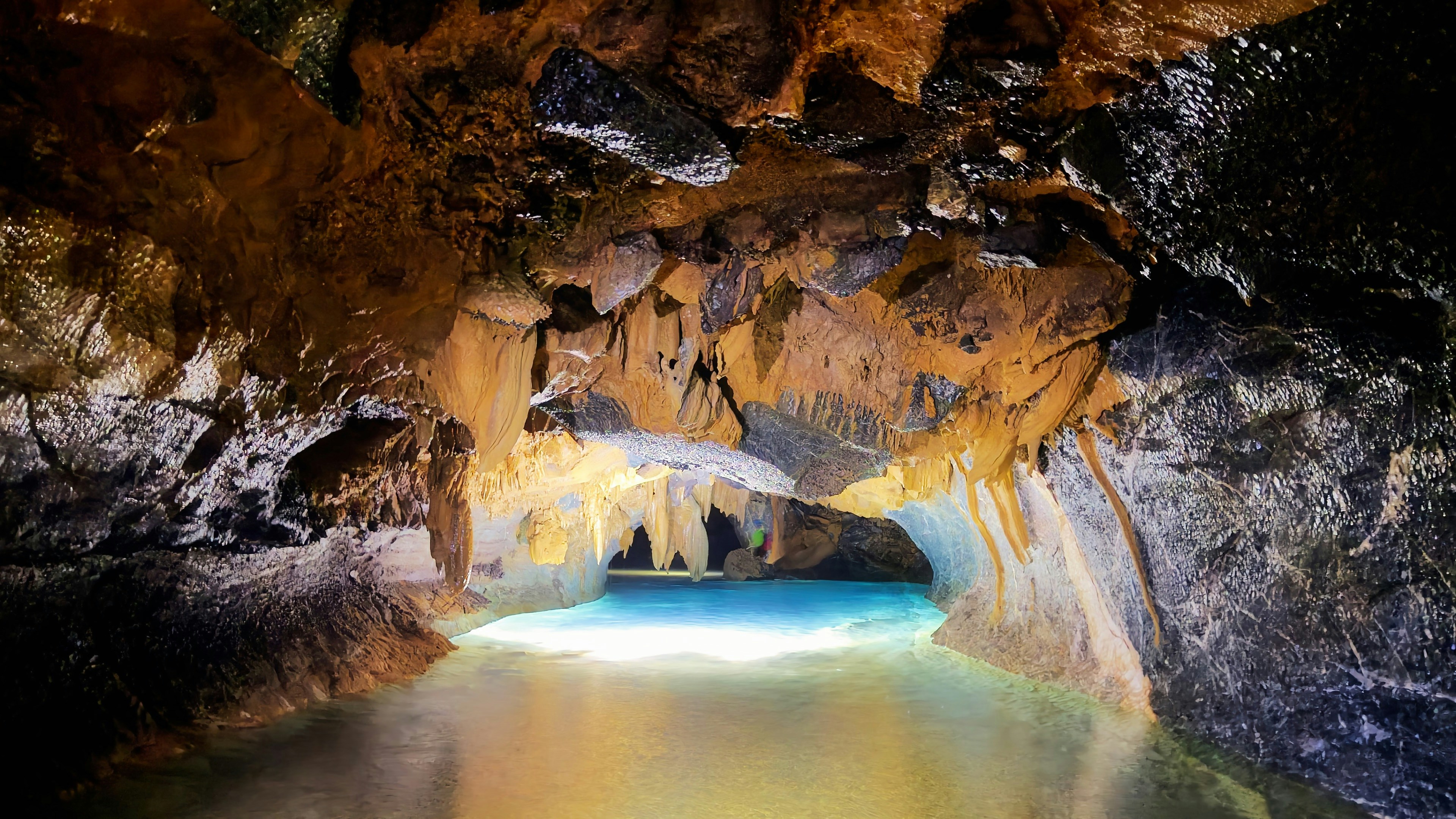 Glowing Tunnel: Cyan Water under a Cavern Arch