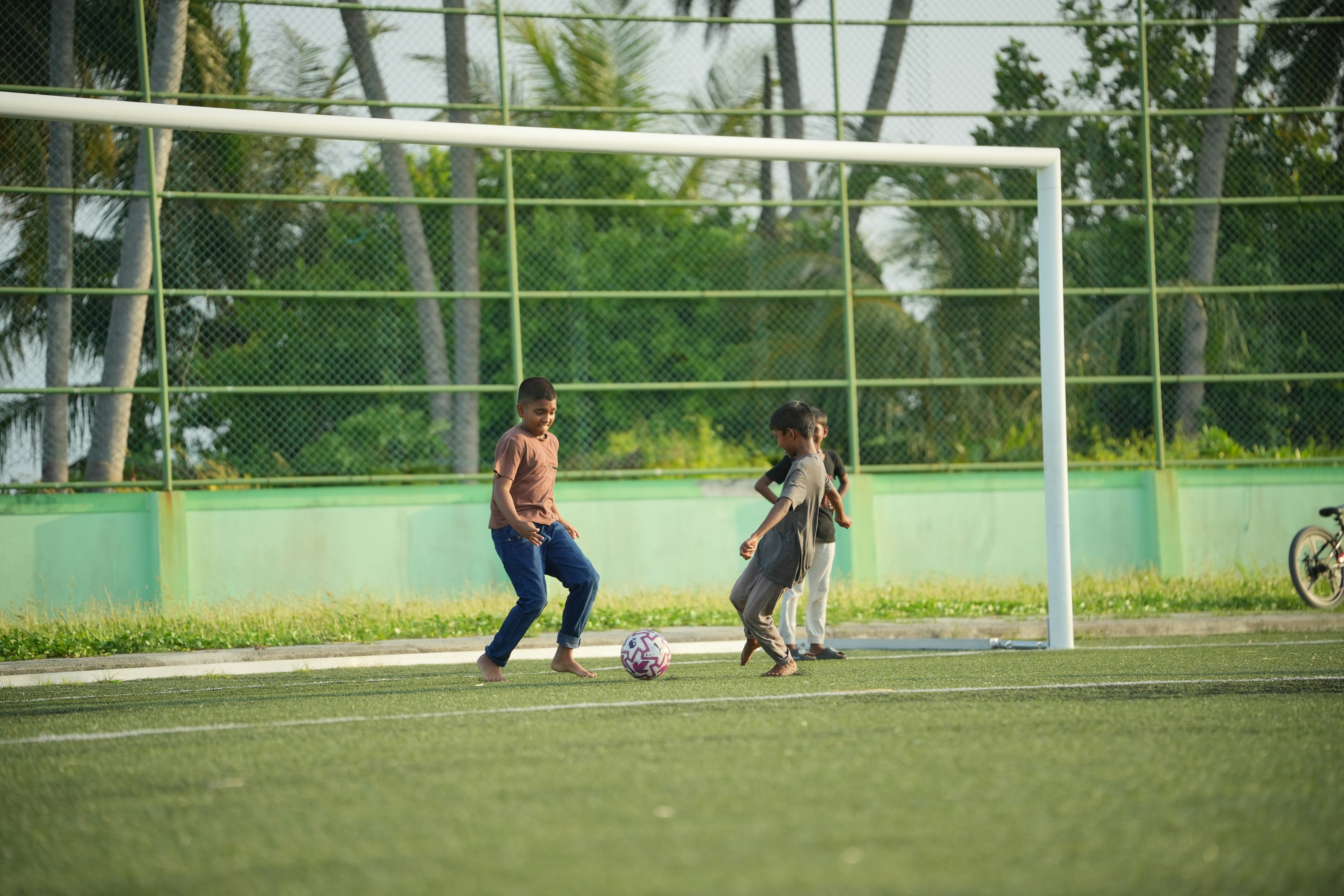 Moment of Play: Youths Contend for the Ball at the Goalmouth