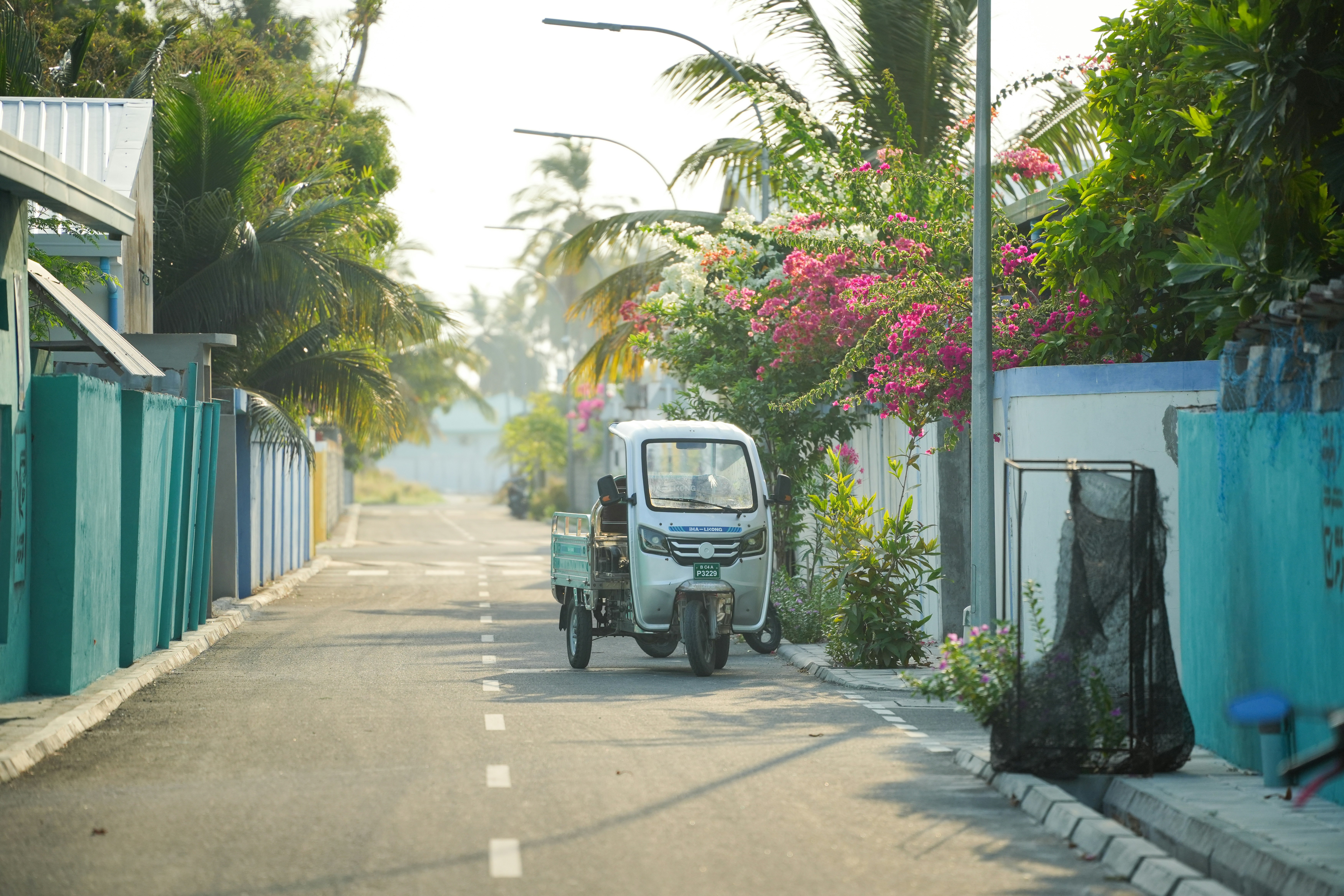 Quiet Rural Street with a Striding Three-Wheeler