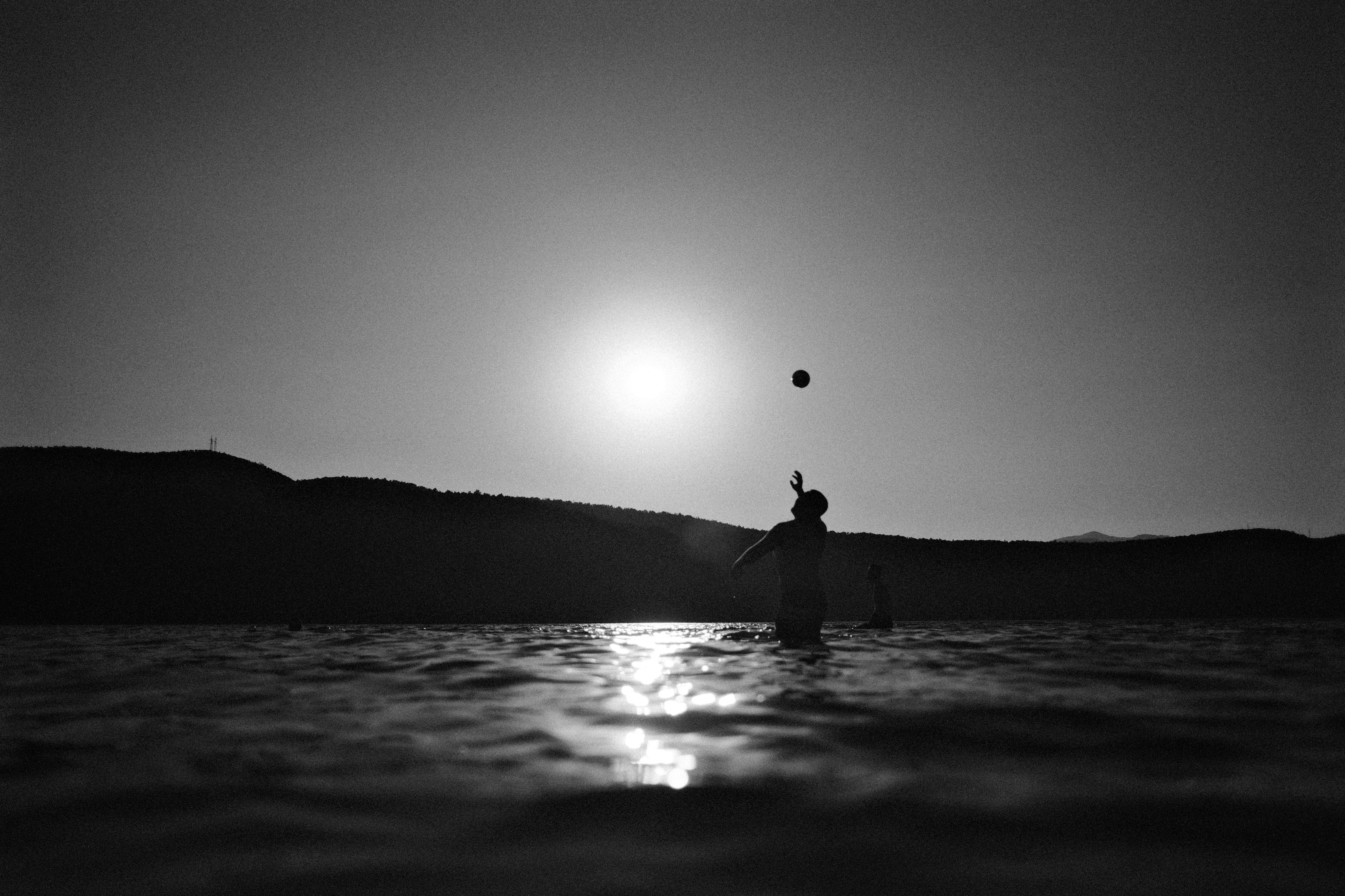 Silhouette over Still Water at Sunset