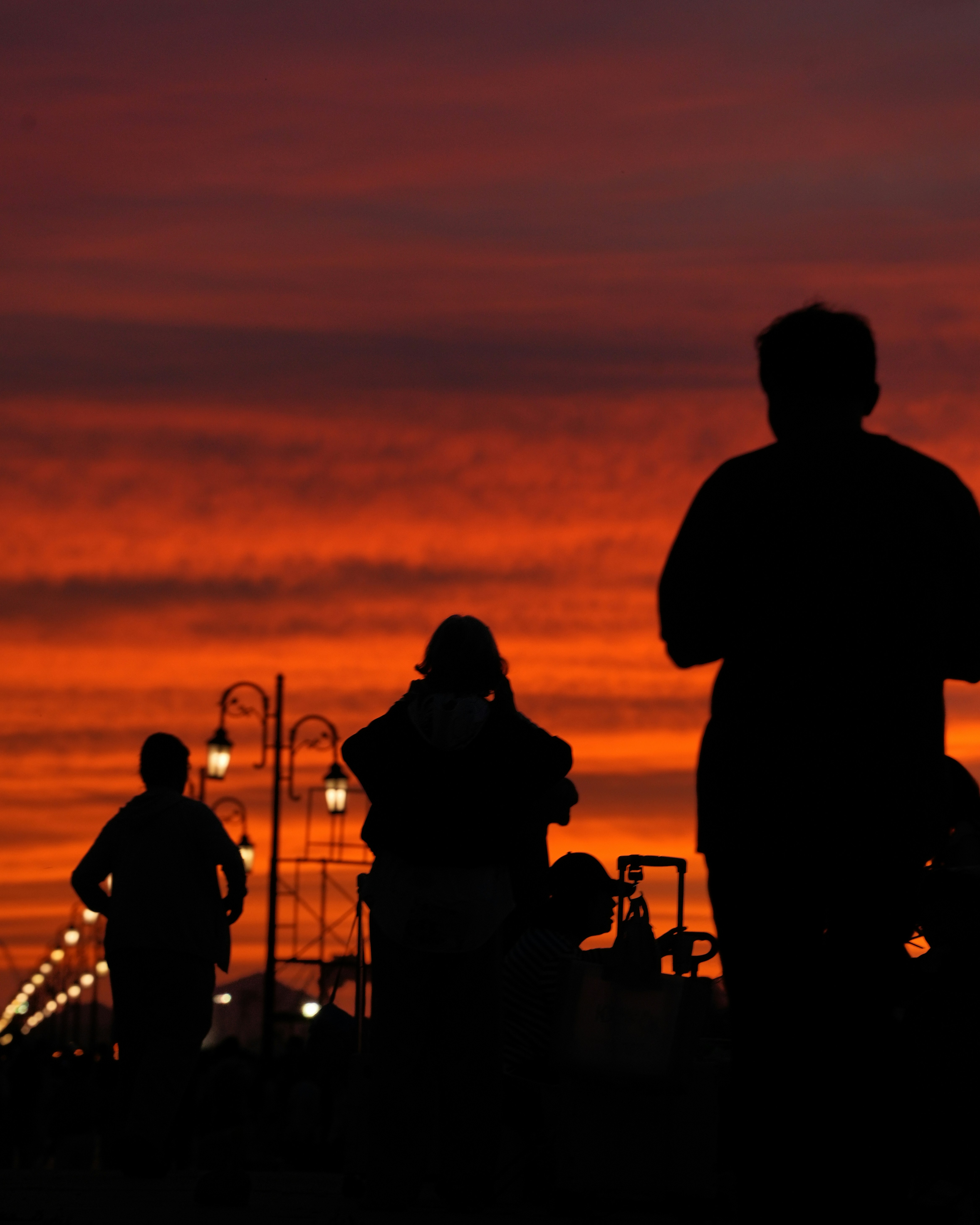 Dusk silhouettes on a sunward promenade