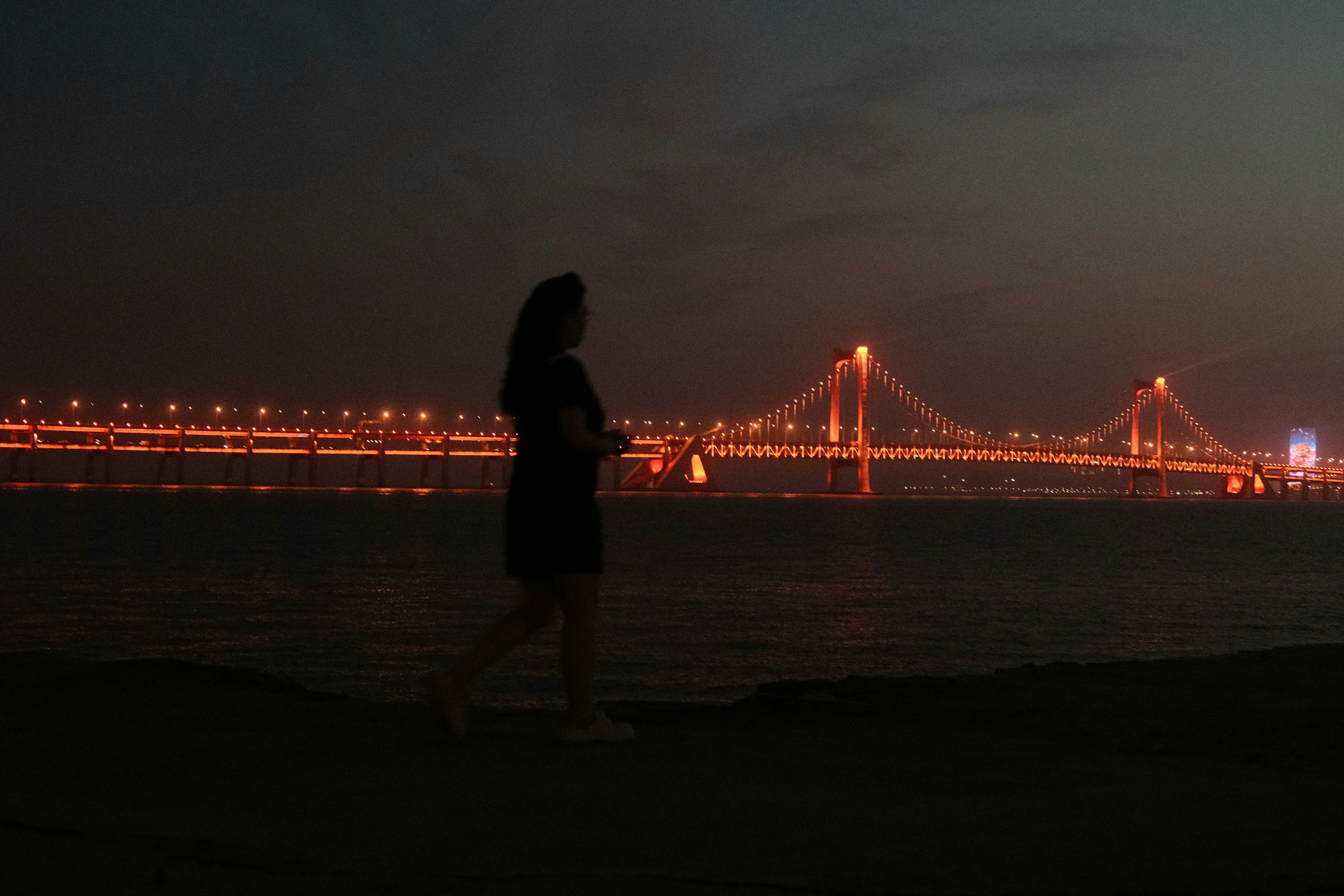 Silhouette by the Harbor: Night Walk under Lanterns