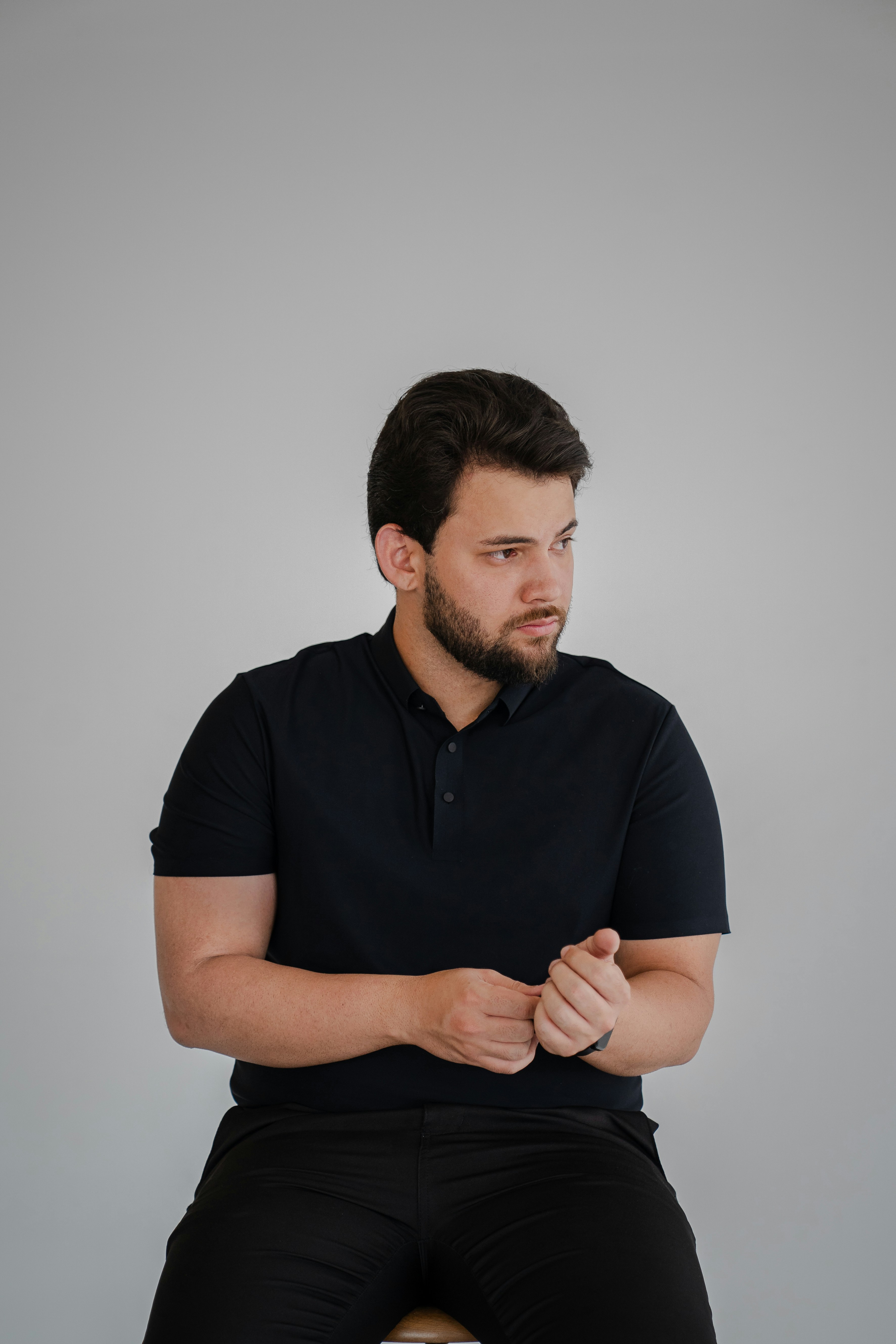 Subtle Confidence: A Seated Portrait in Quiet Studio Light