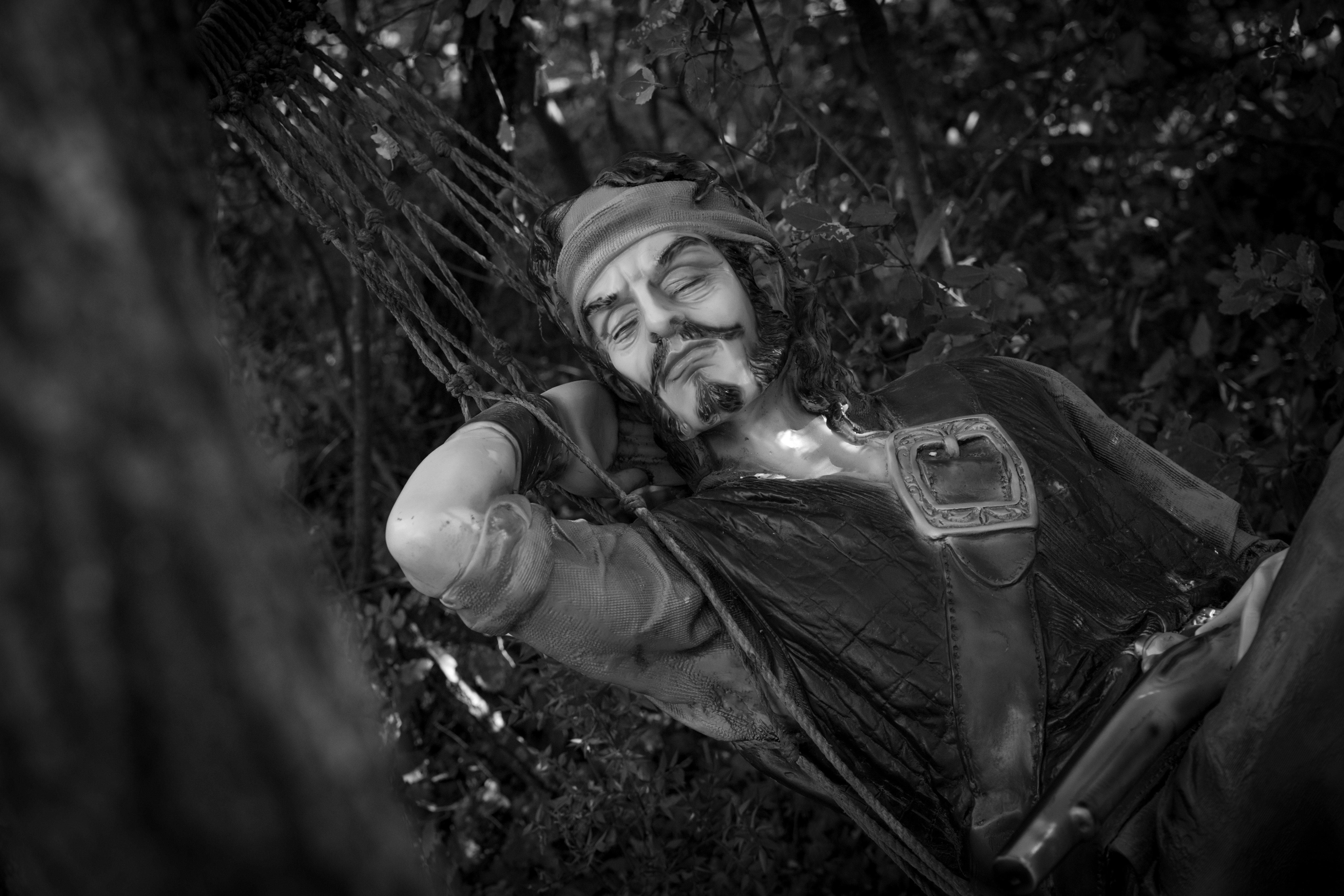 The Reclining Acrobat: A Black-and-White Gaze Beneath a Turban
