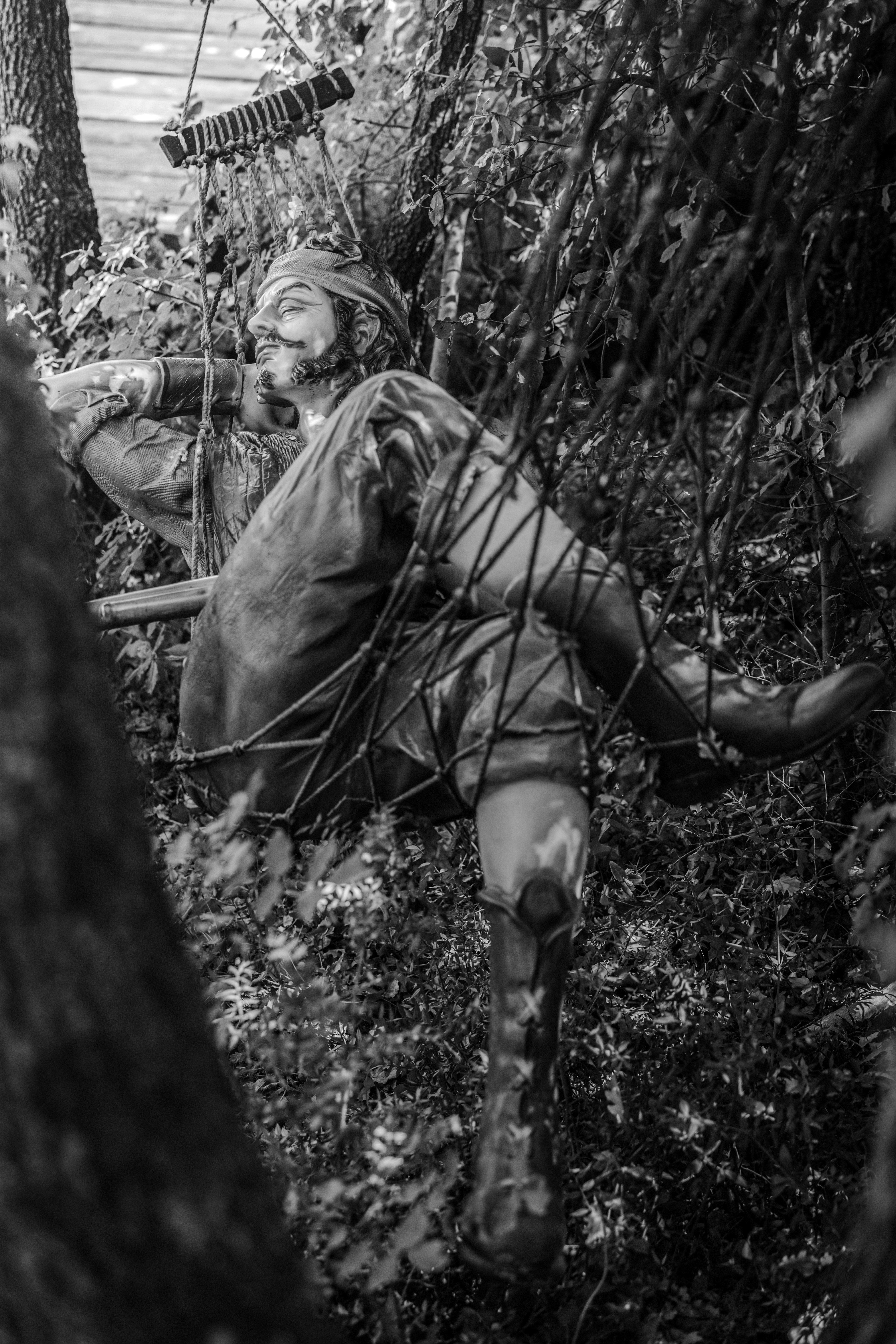 Suspended in Shade: a rugged burlap-clad worker Resting in a Netted Hideaway