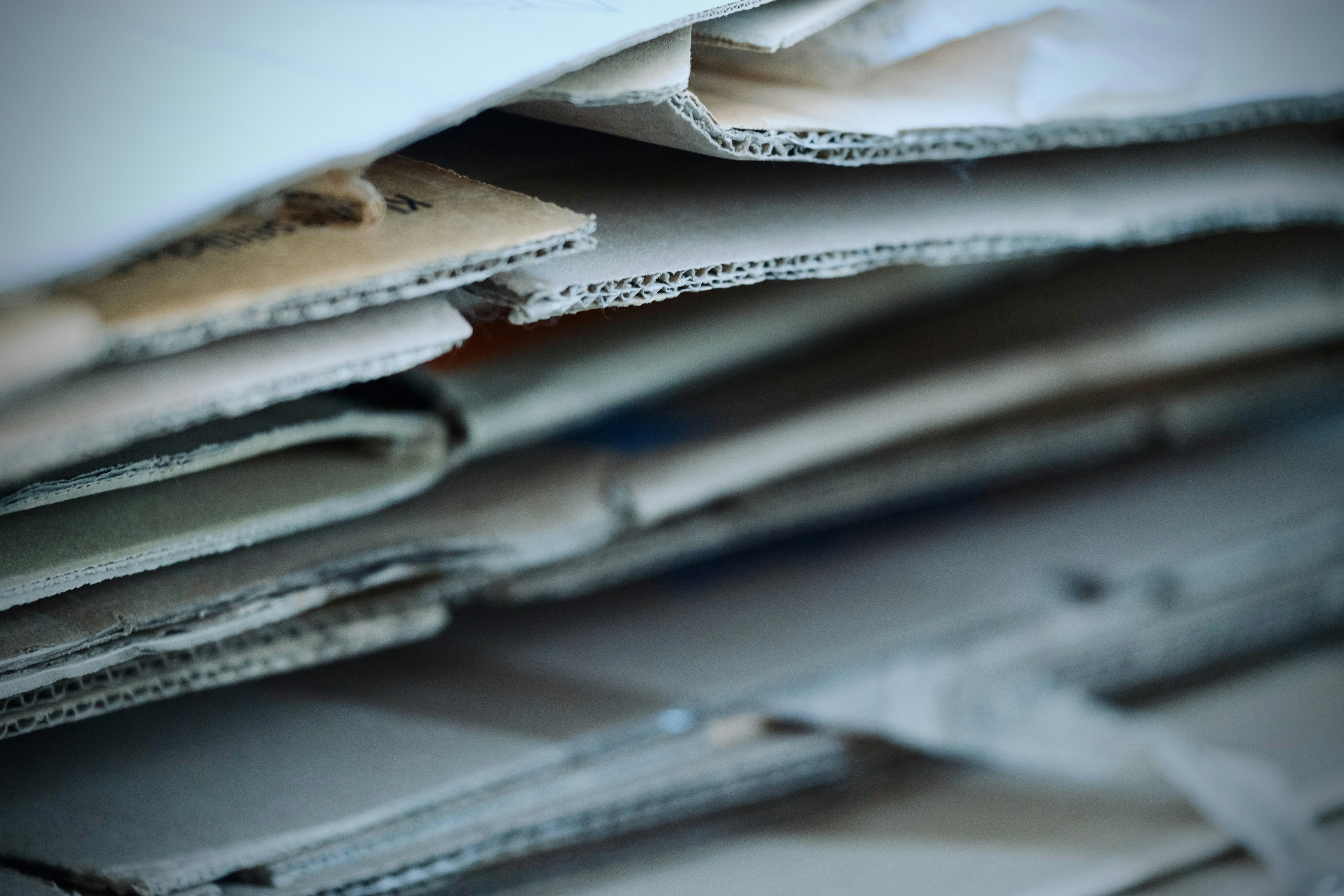 Layers of Paper: A Quiet Stack of Newsprint and Cardboard