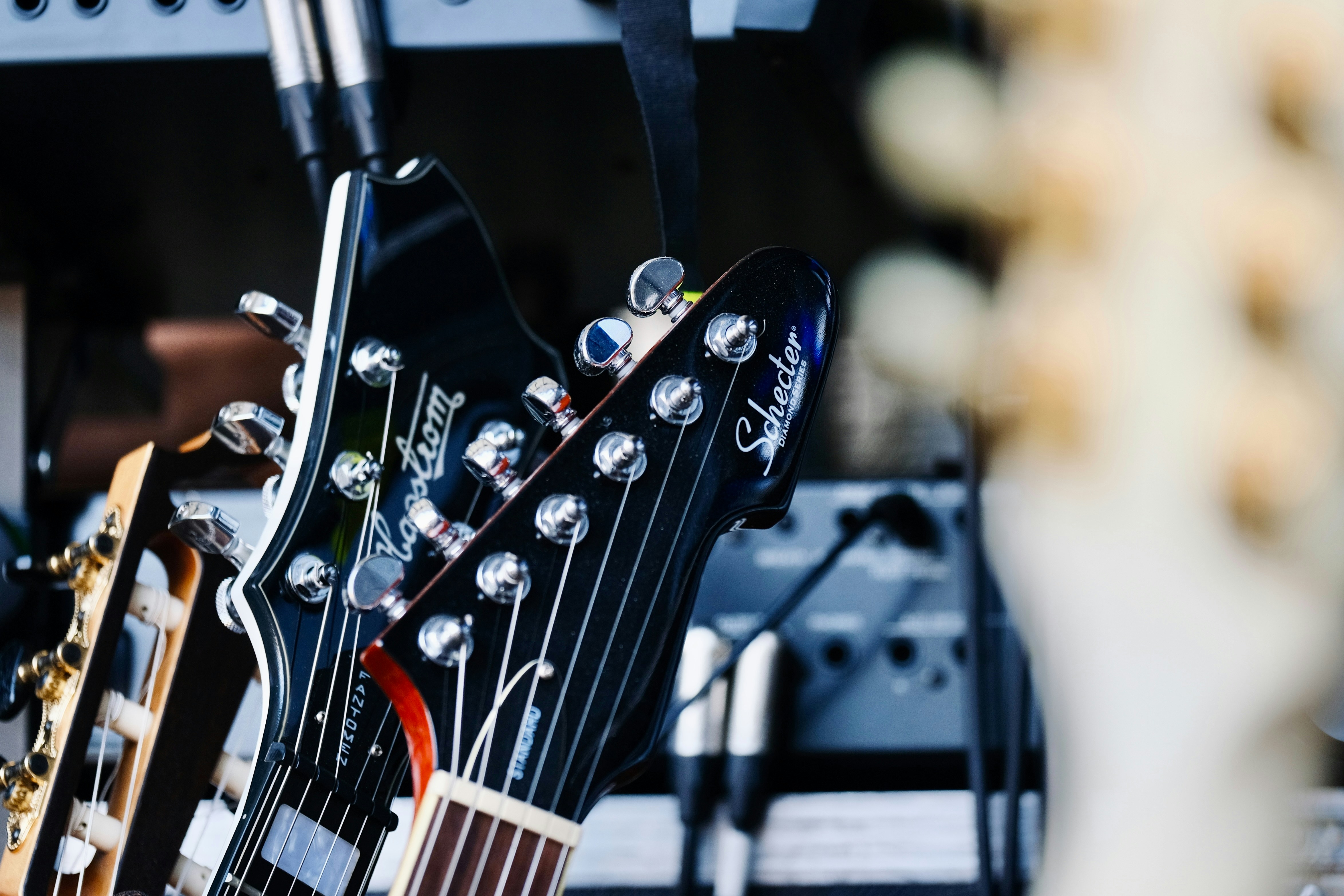 Strings in Focus: A Close-Up of a Guitar Headstock on Stage
