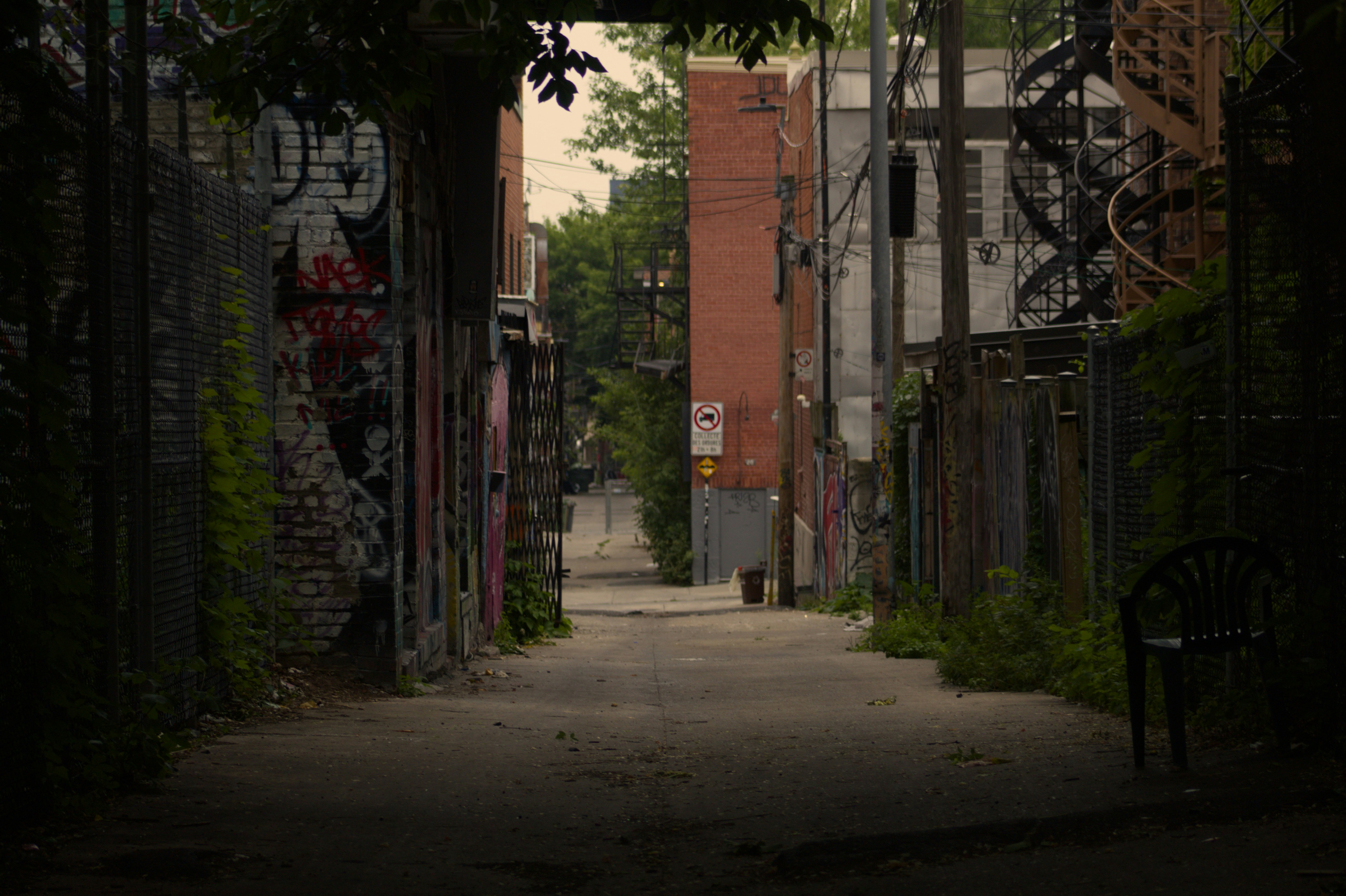 Sunlit corridor: a quiet alley leading to distant daylight