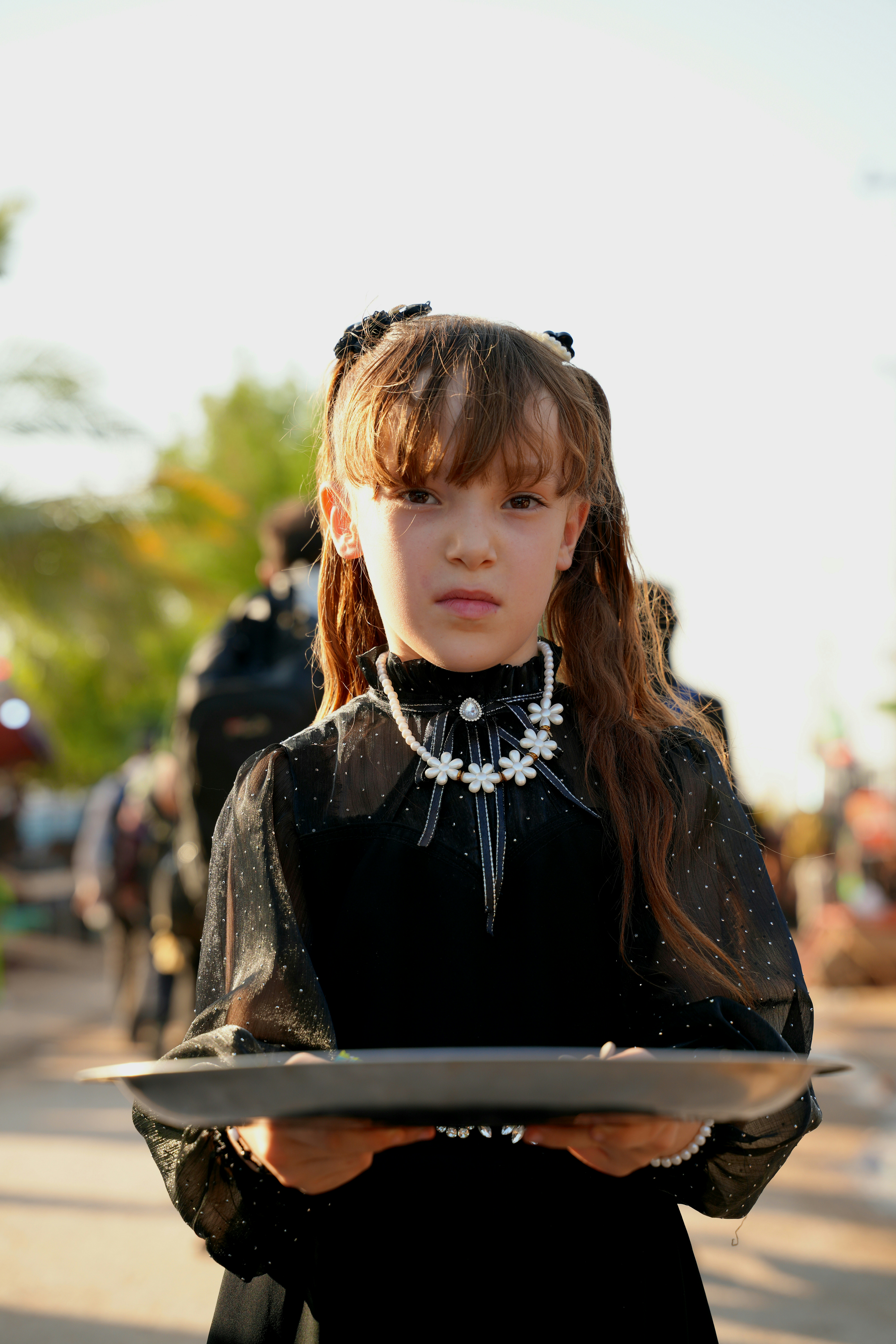 Young Presenter in Black Lace: A Quiet Moment with a Plate