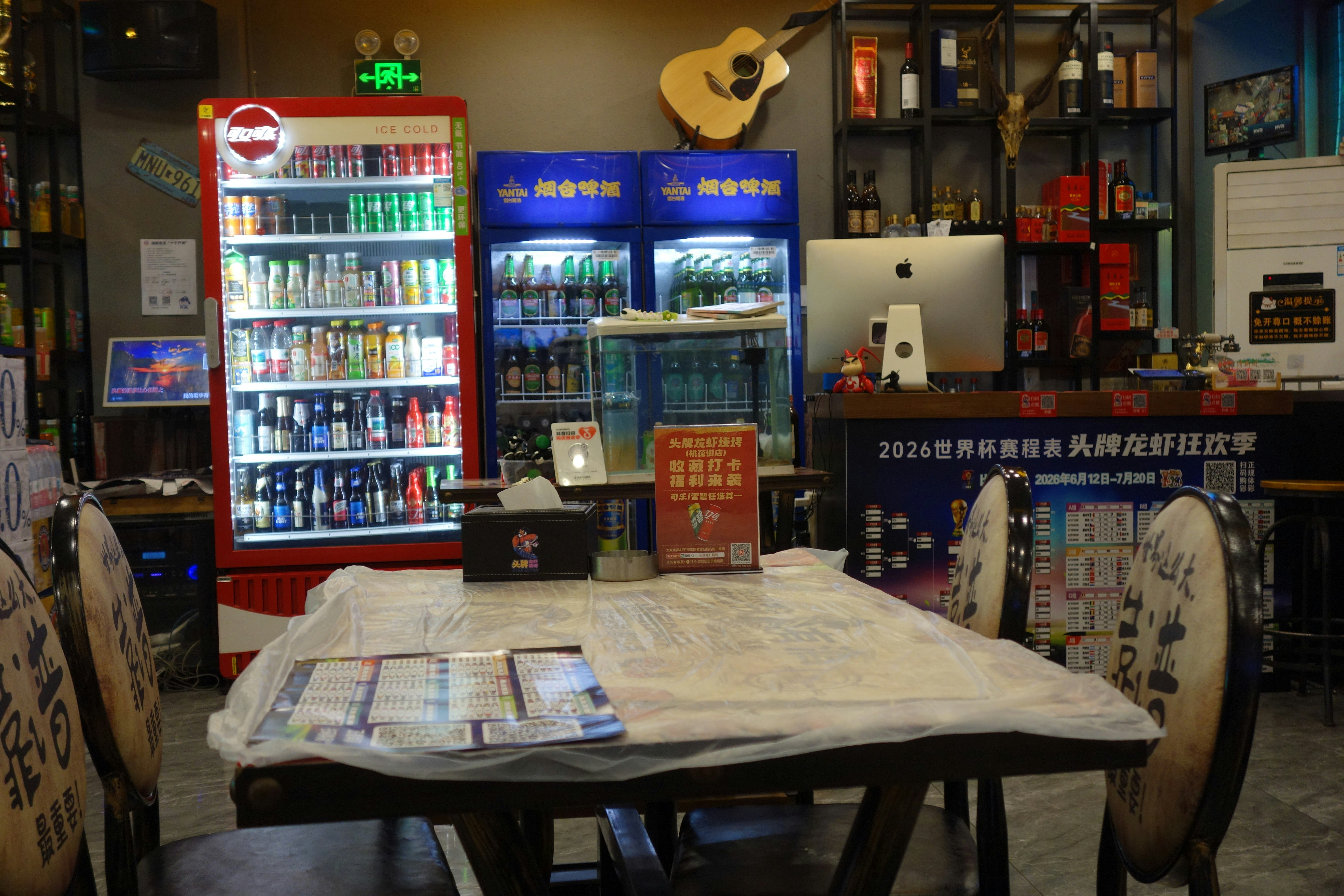 Table at the Cozy Café Studio with Backlit Beverage Fridge and Guitar Decor