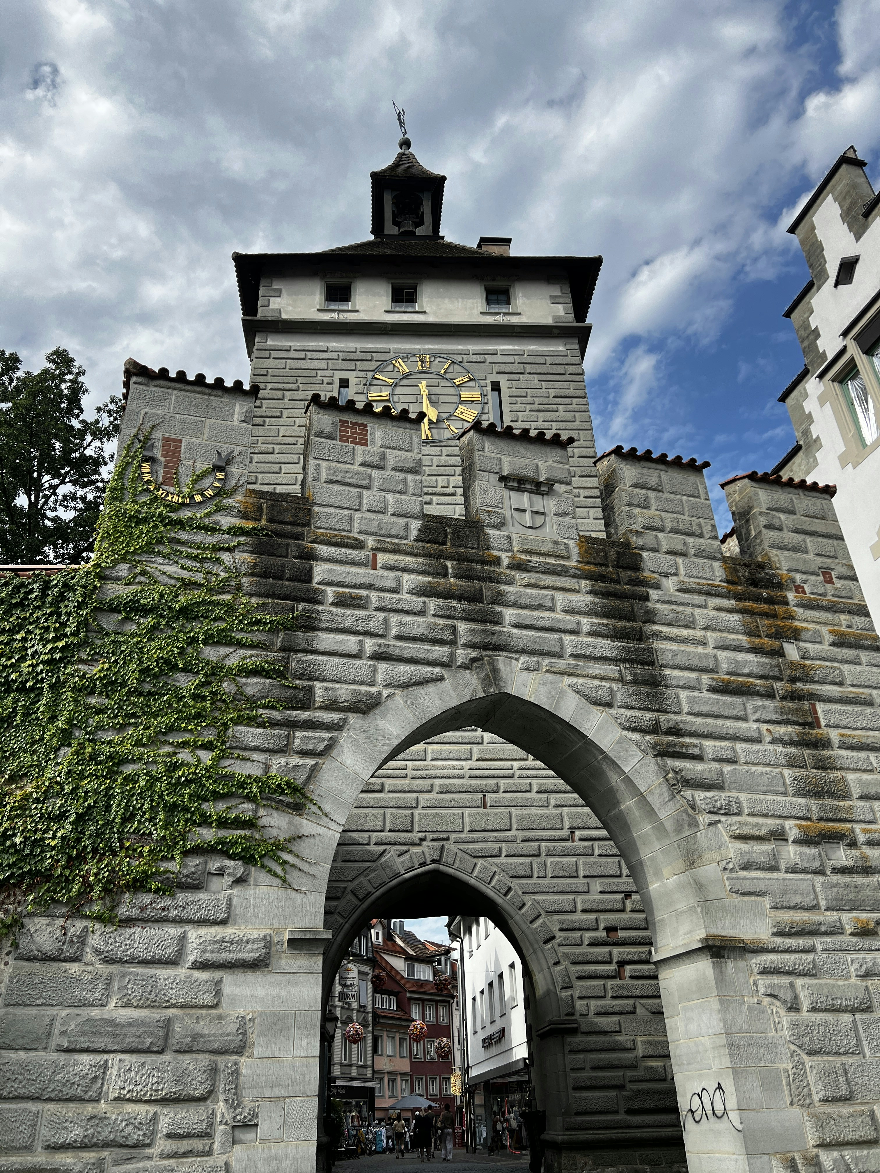 Clocked Gate: A Medieval Arch Framing a Town Village