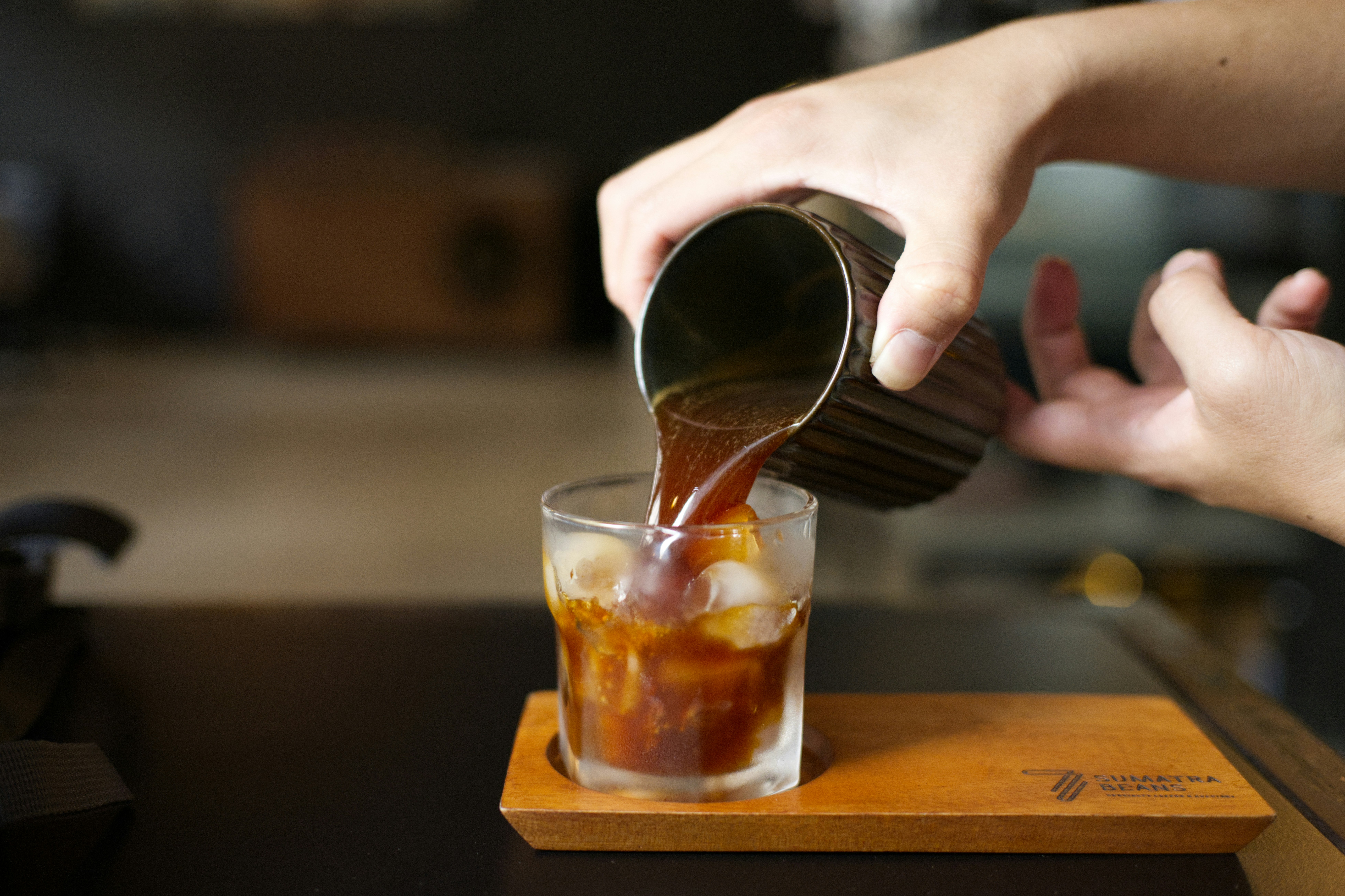 Pouring Espresso Nectar: A Barista’s Craft in Motion