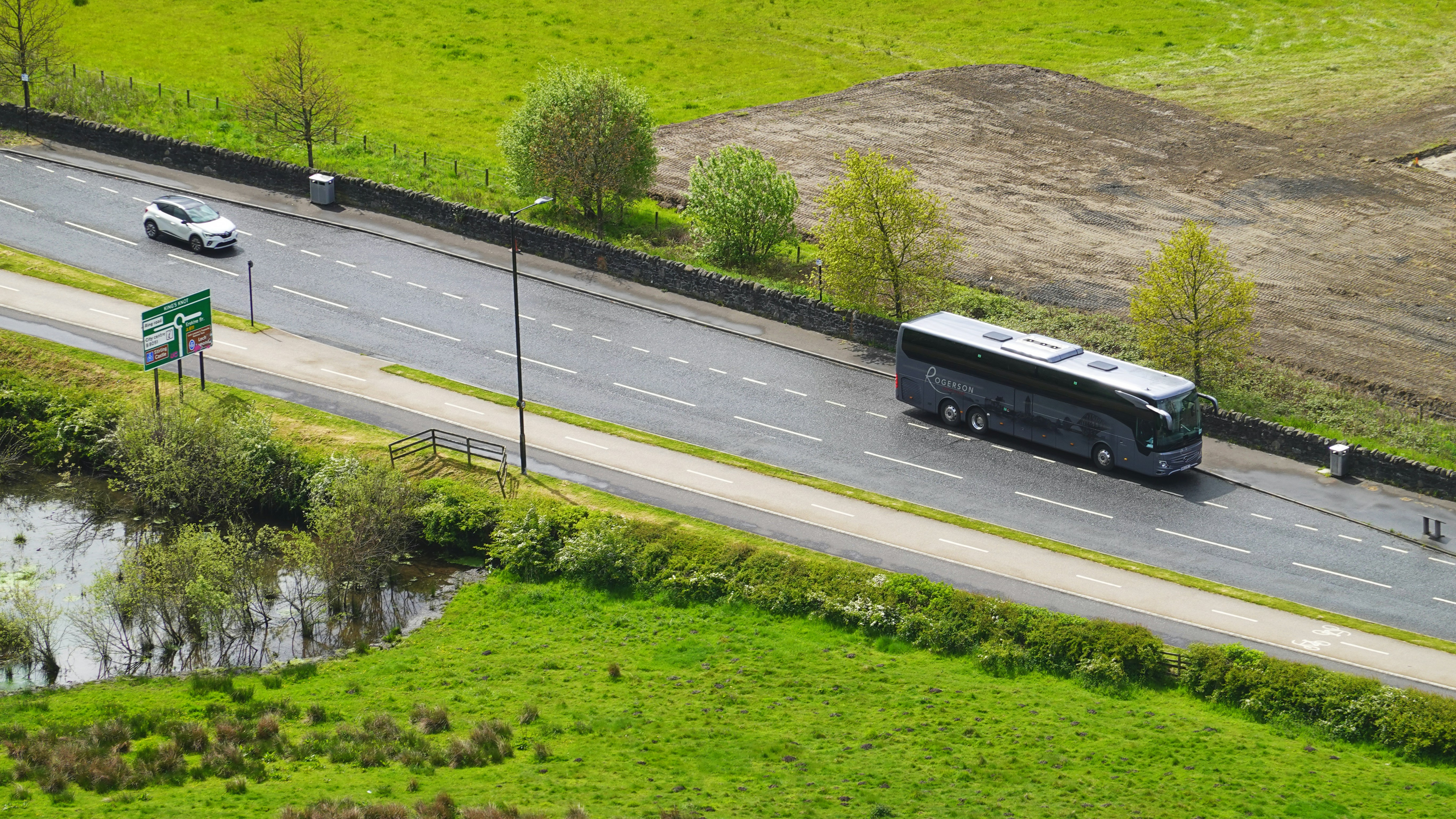 Bus on a Quiet Ribbon: Aerial View of a Roadbound Corridor