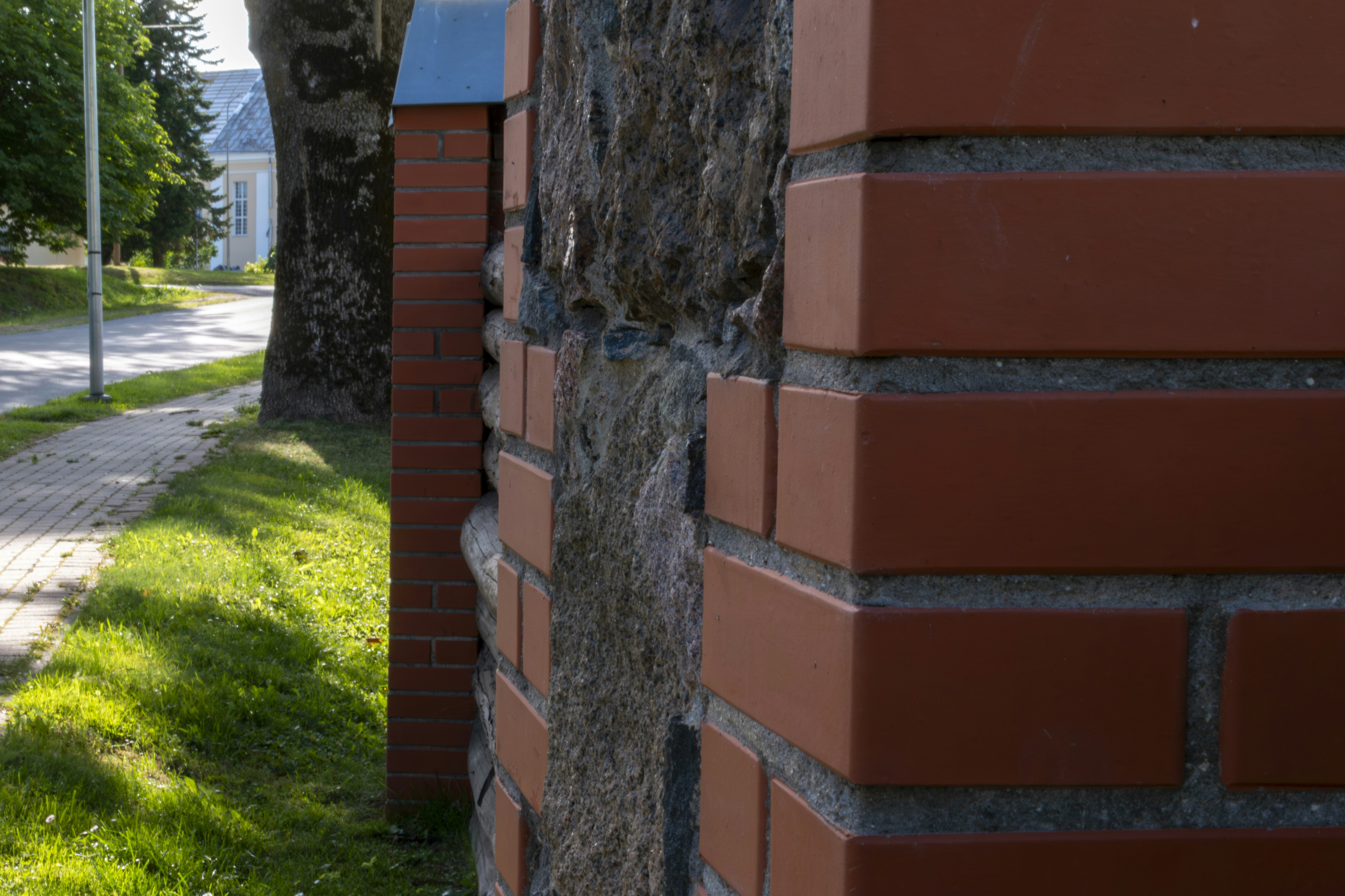 Brick Wall Pierces the Park: A Quiet Edge of Daylight