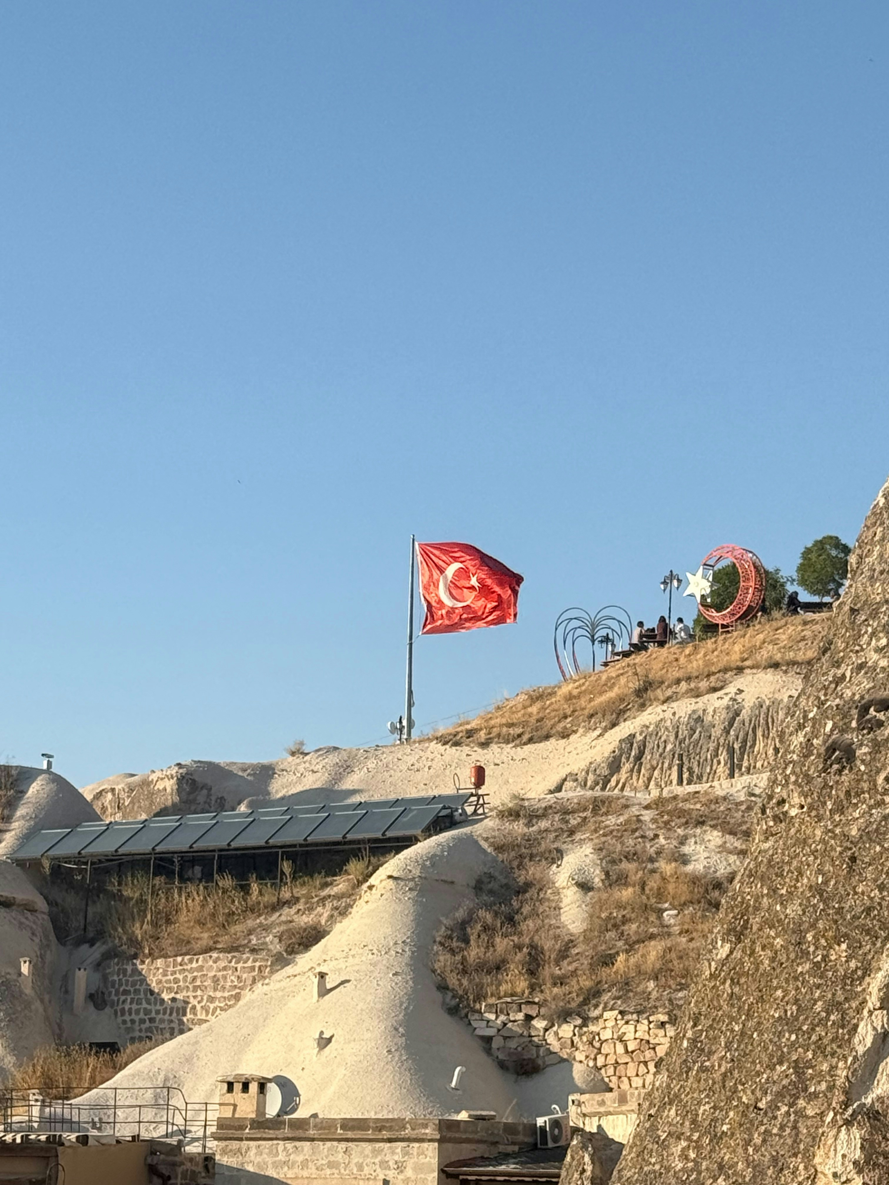 Flag on the Cliff: Turkish Emblem Above the Ancient Quarry
