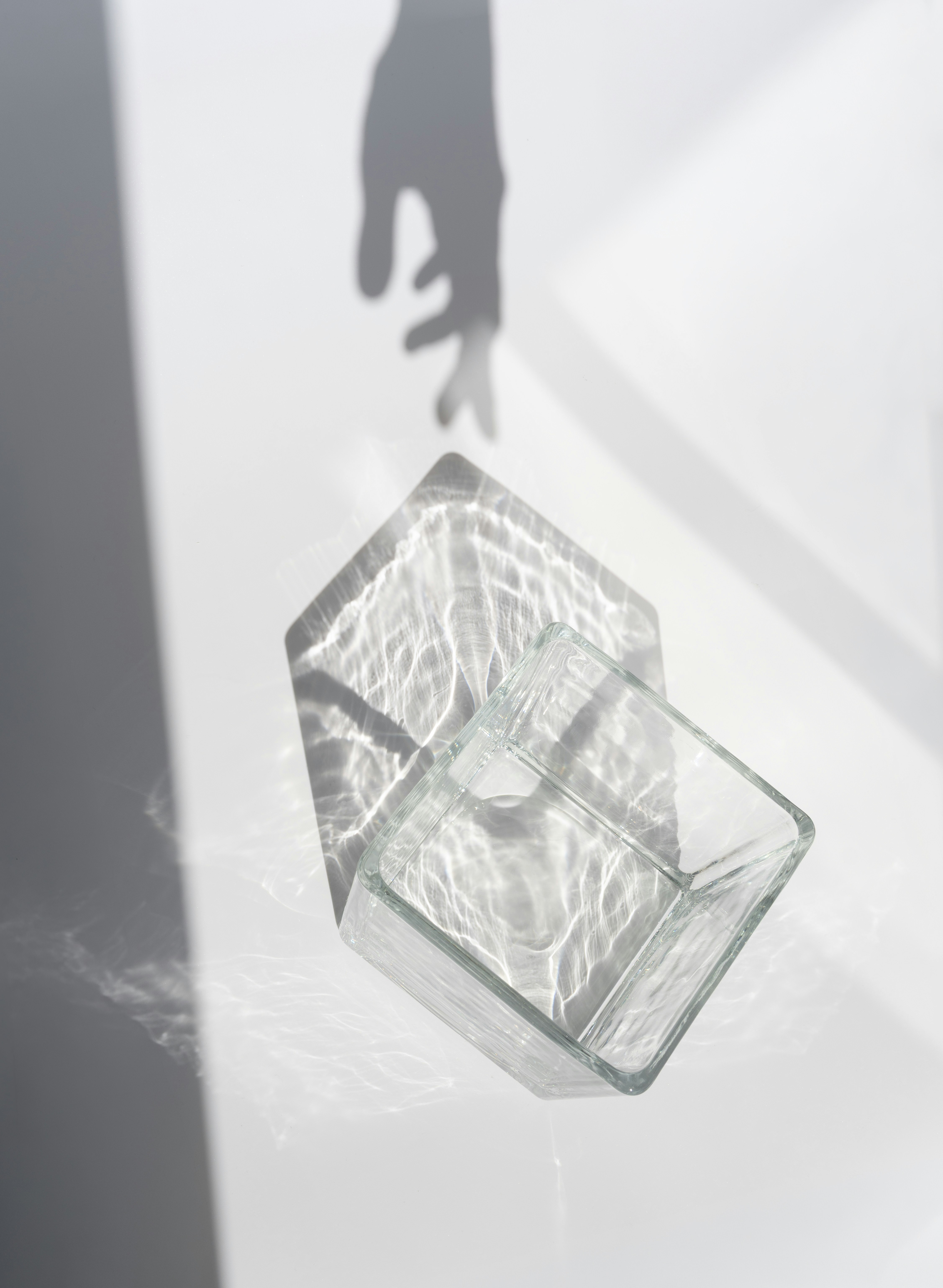 Shadowed Hand and Tilted Glass: Abstract Light Play