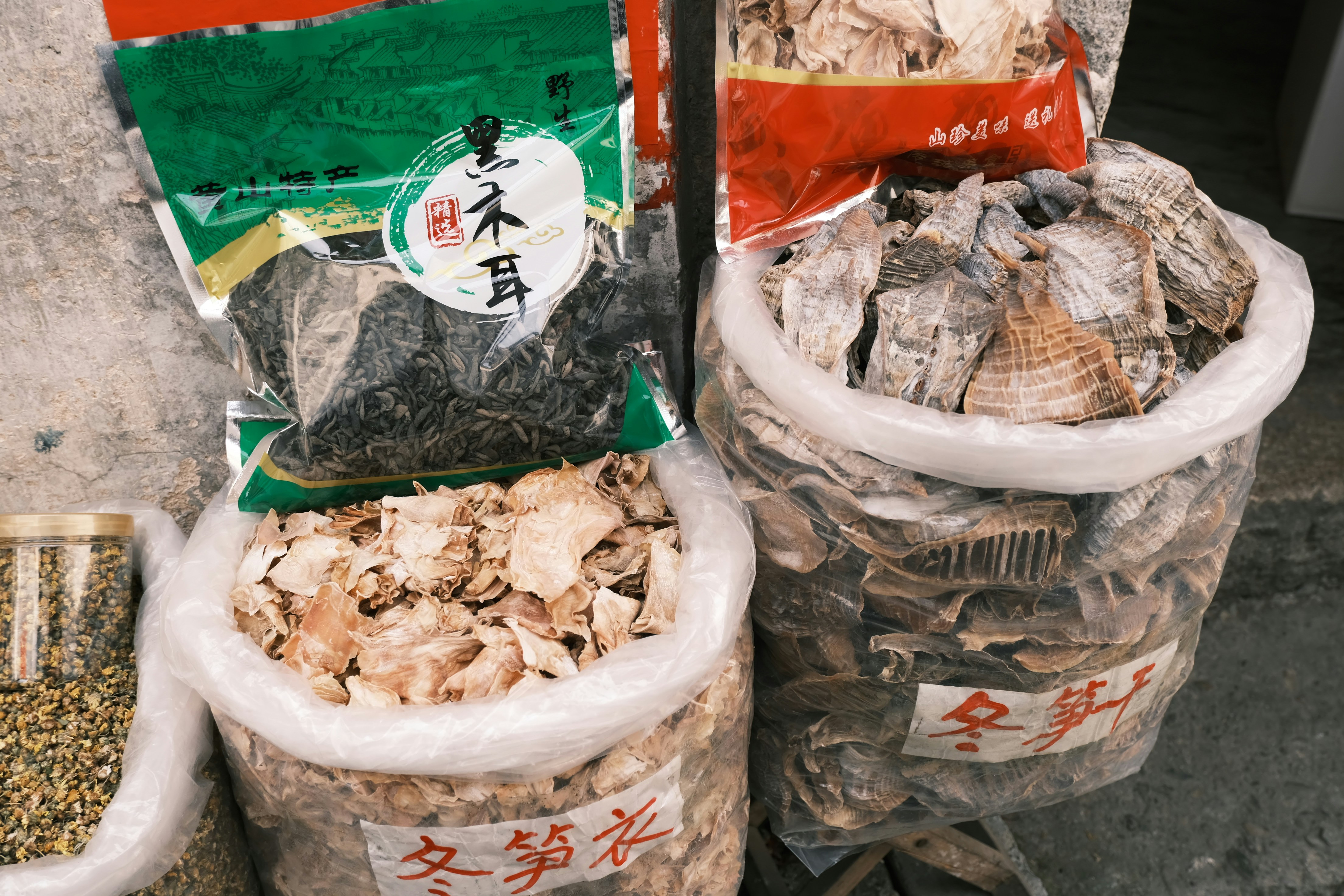 Dry Wood Chips and Packed Noodles: Street Market Bins in Colorful Packaging