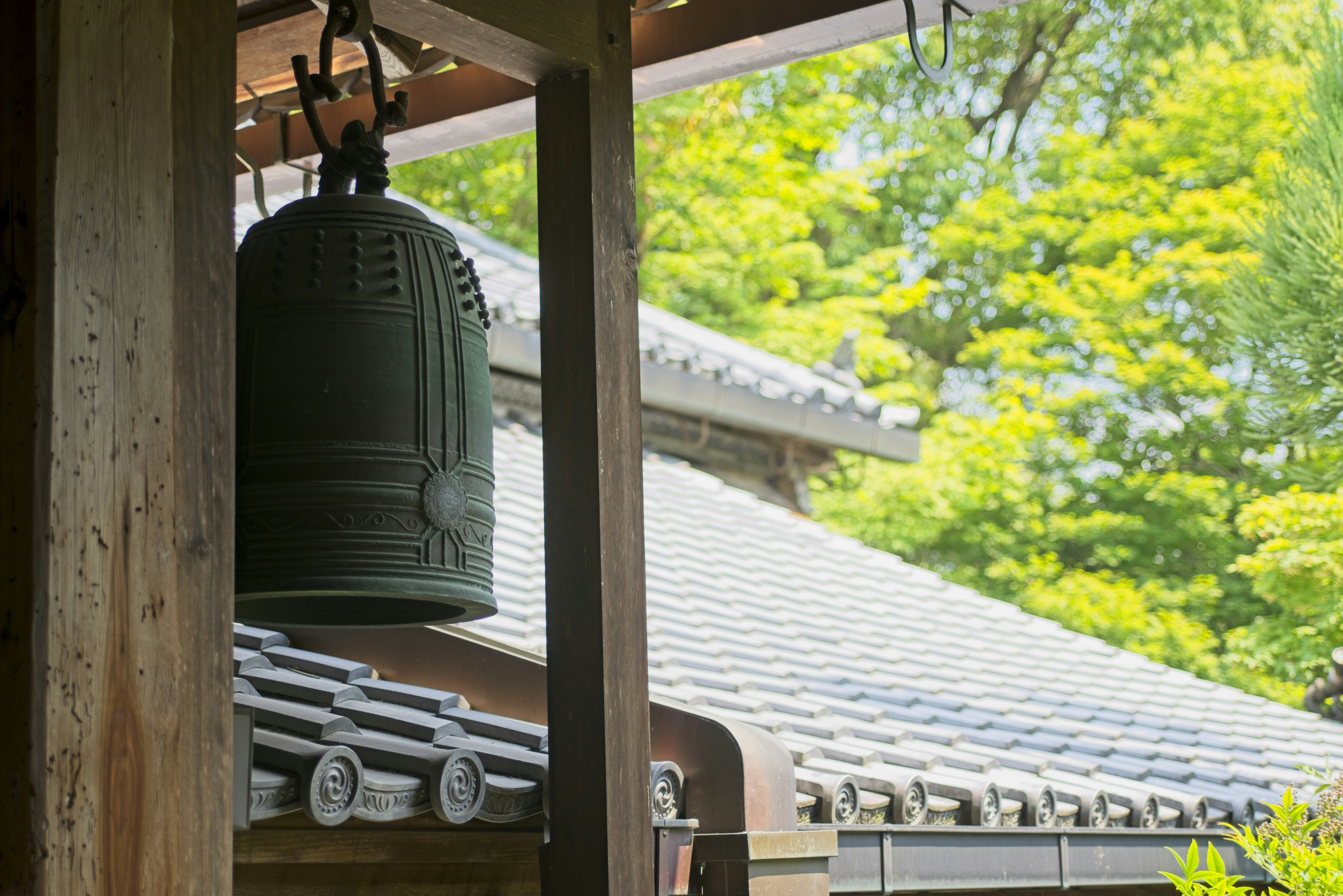 Suspended Bell Beneath Timber Beams at a Tranquil Japanese Terrace