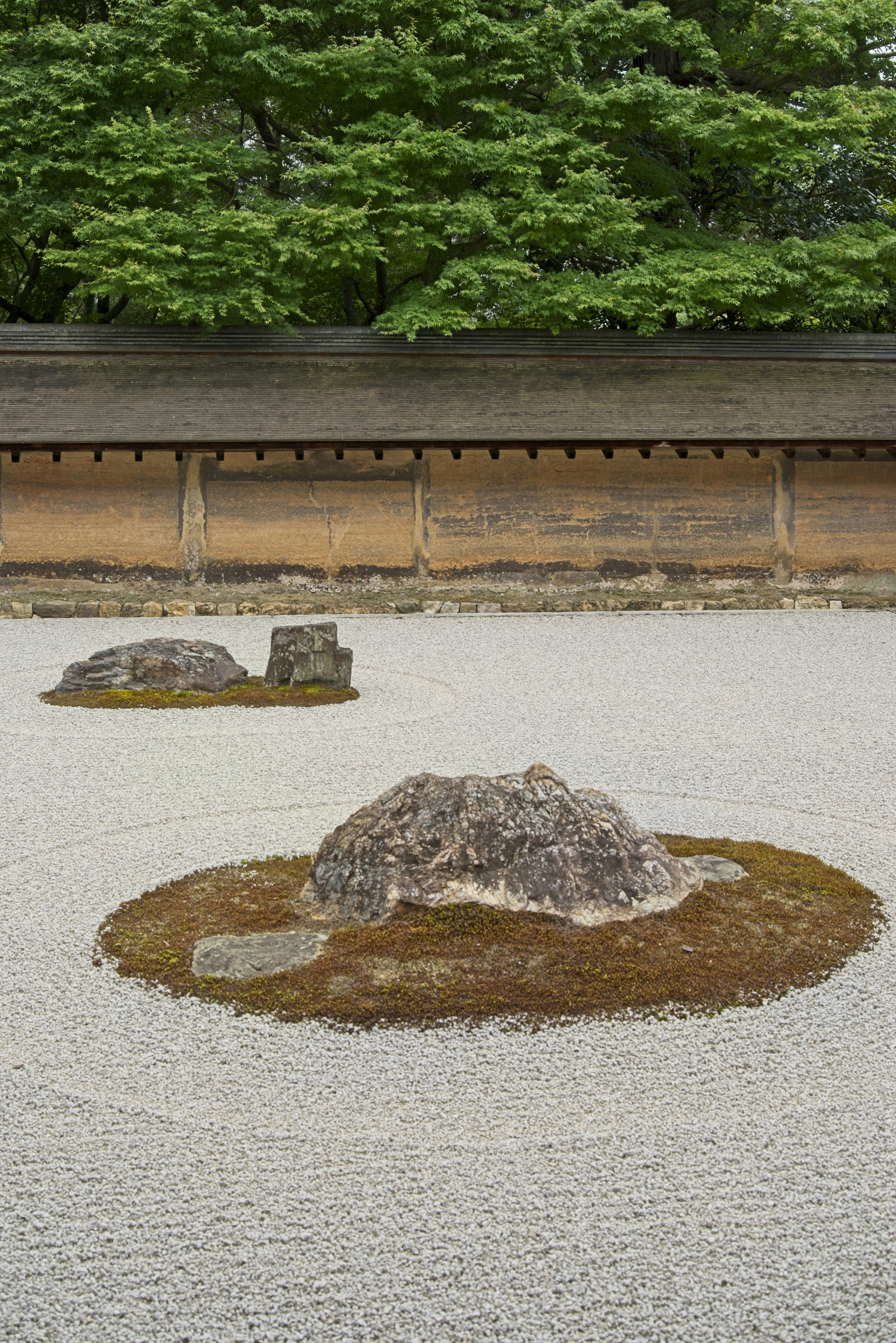 Zenyen Rock Garden on Raked Gravel with a Placid Stonehenge Wall