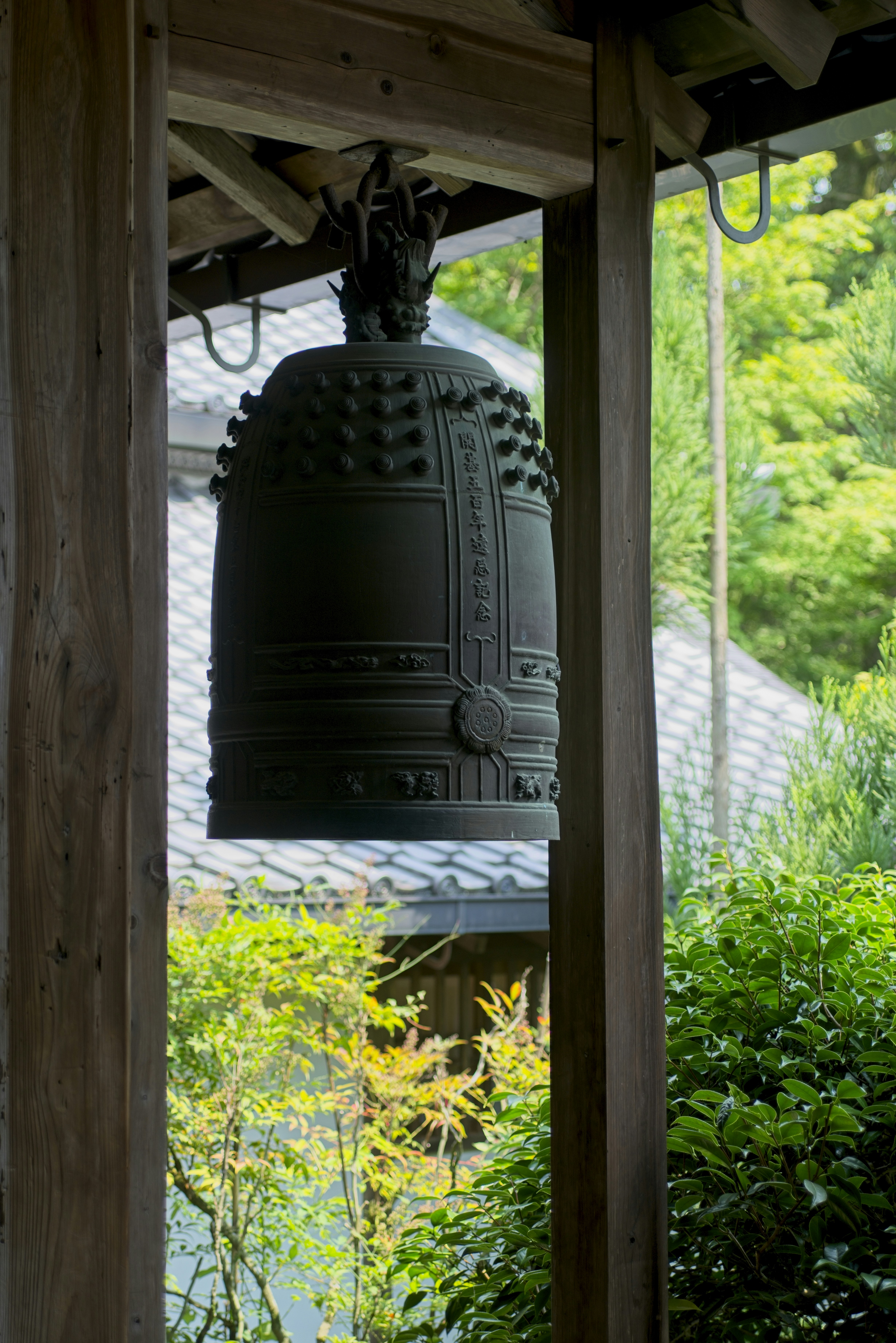 A Weathered Bell Framed by Garden Light