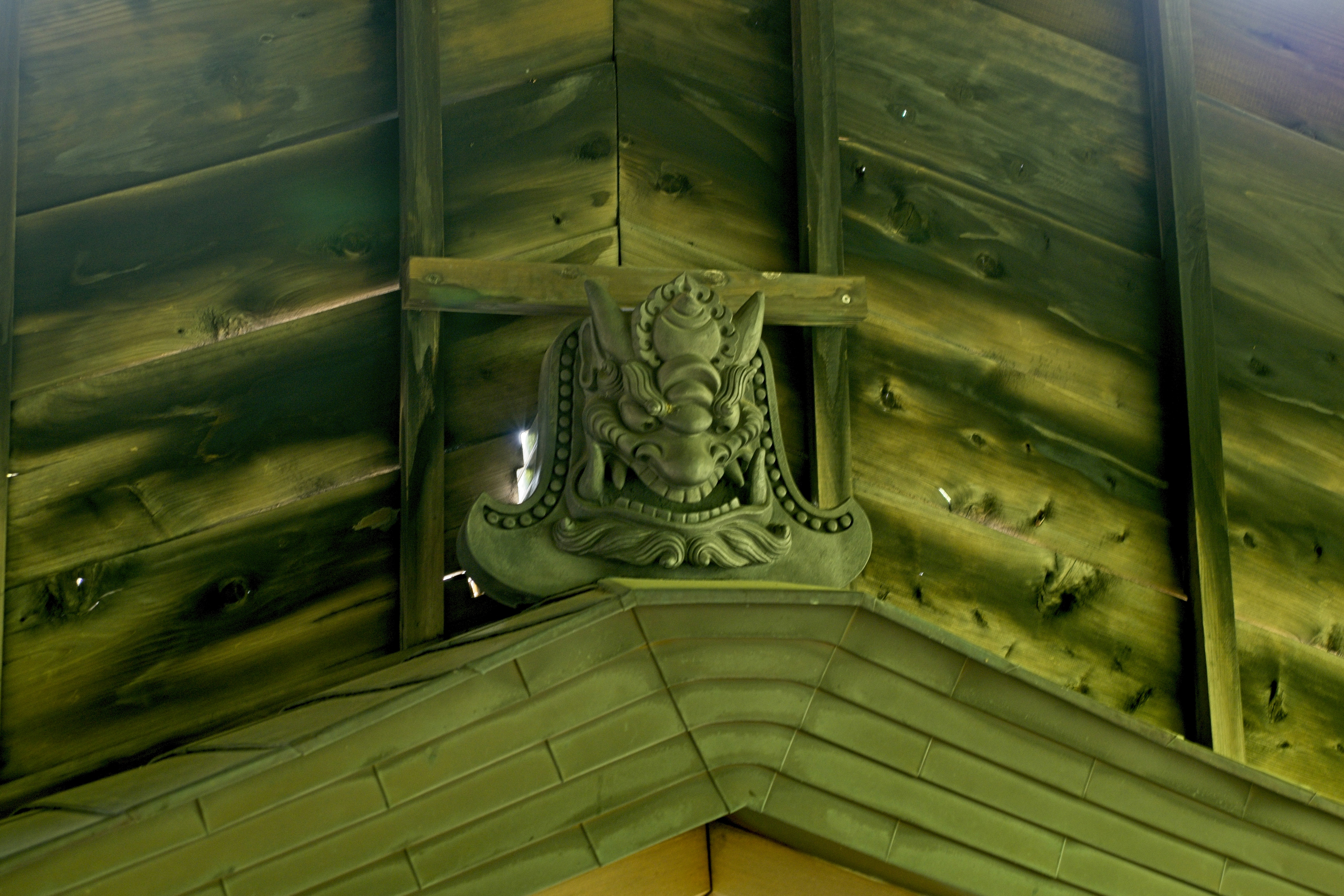 Ornate Dragon Crest Framing a Wooden Peak
