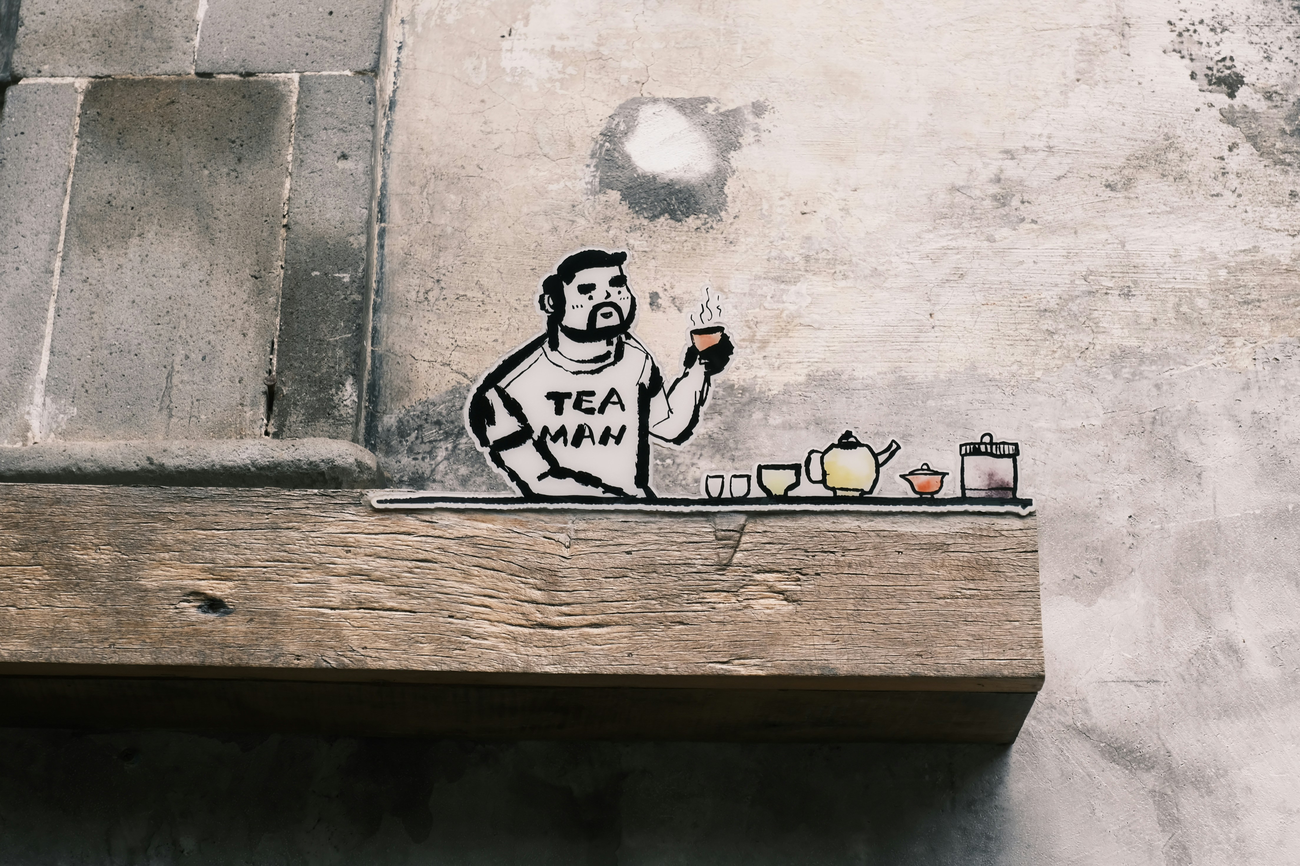 Tea Man at the Edge: A Tiny Café Sketch on Concrete