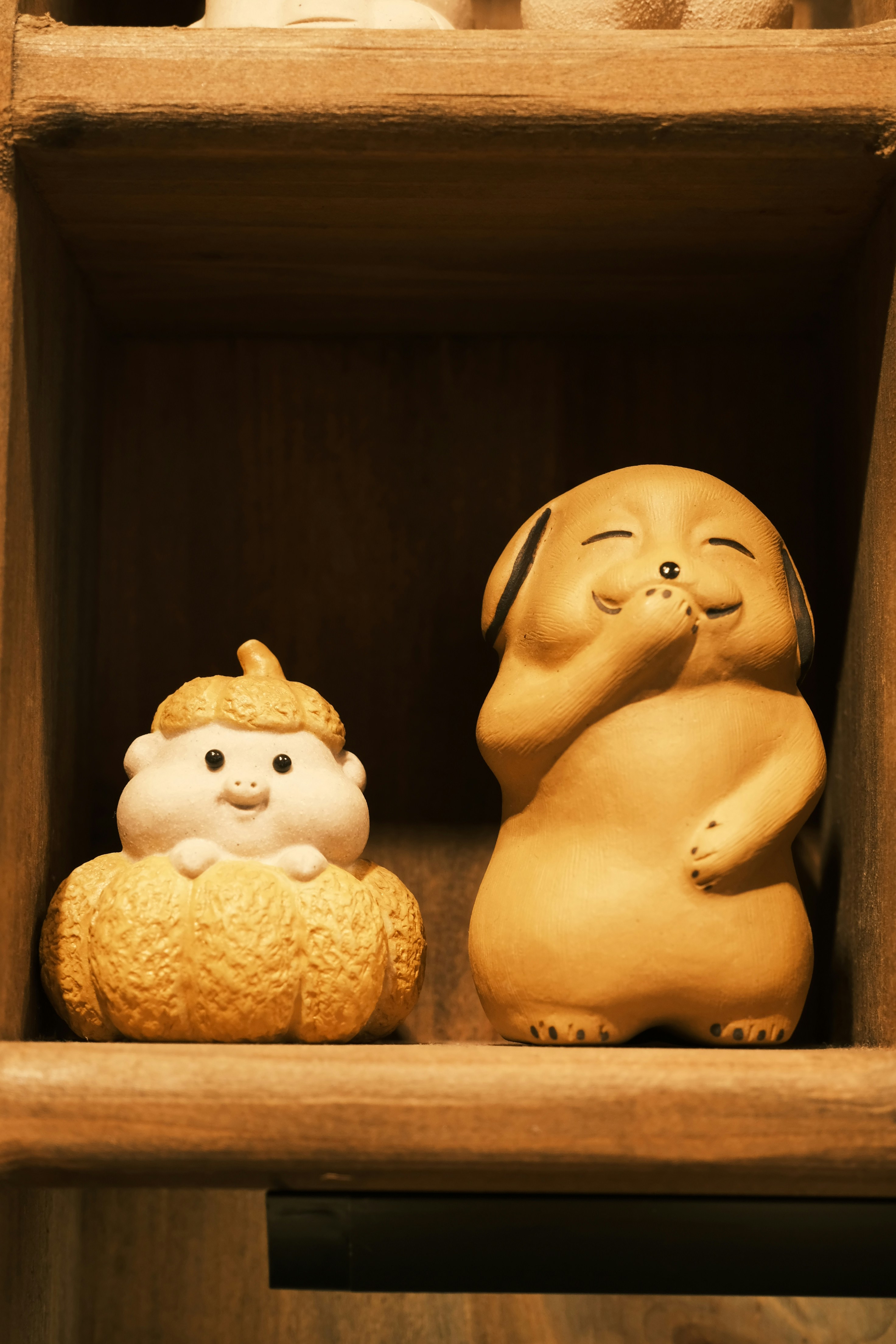 Two Ceramic Fables: A Laughing Buddha and a Chuckling Cloud-Head